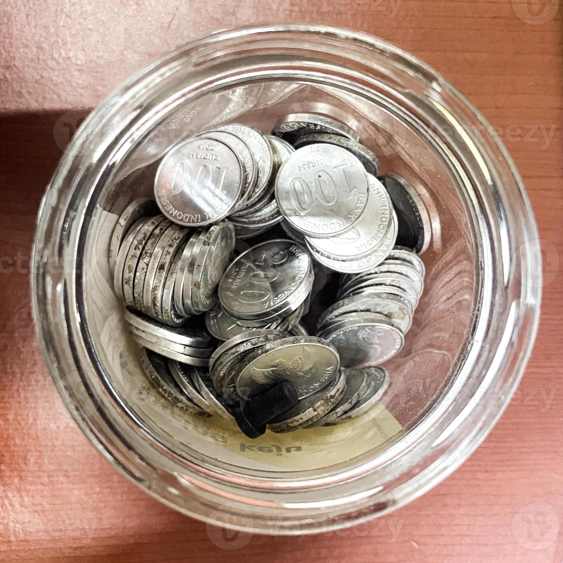 top view glass tip jar containing rupiah coins 46931557 Stock Photo at Vecteezy