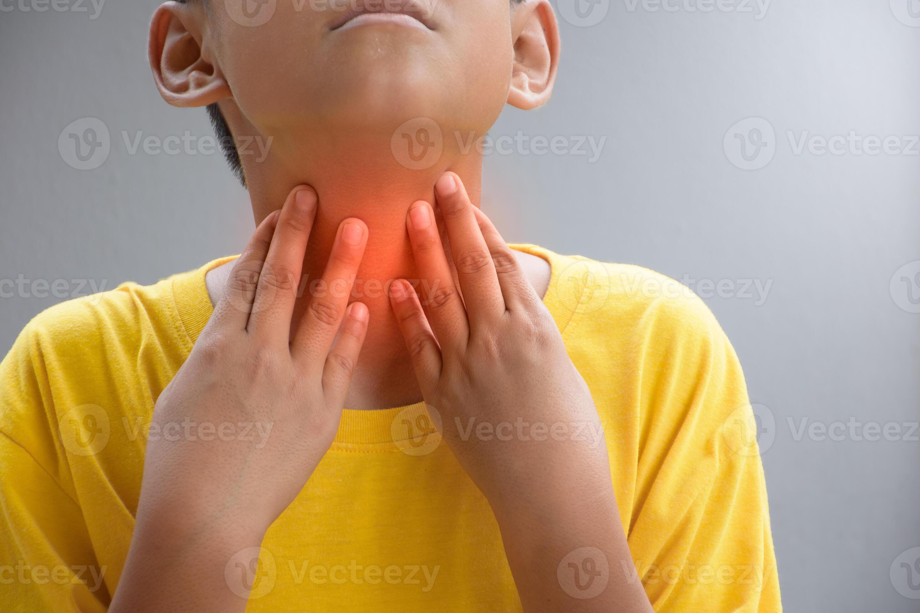 Asian boy touching the neck due to a sore throat or Itching in the throat causes of Irritation ...