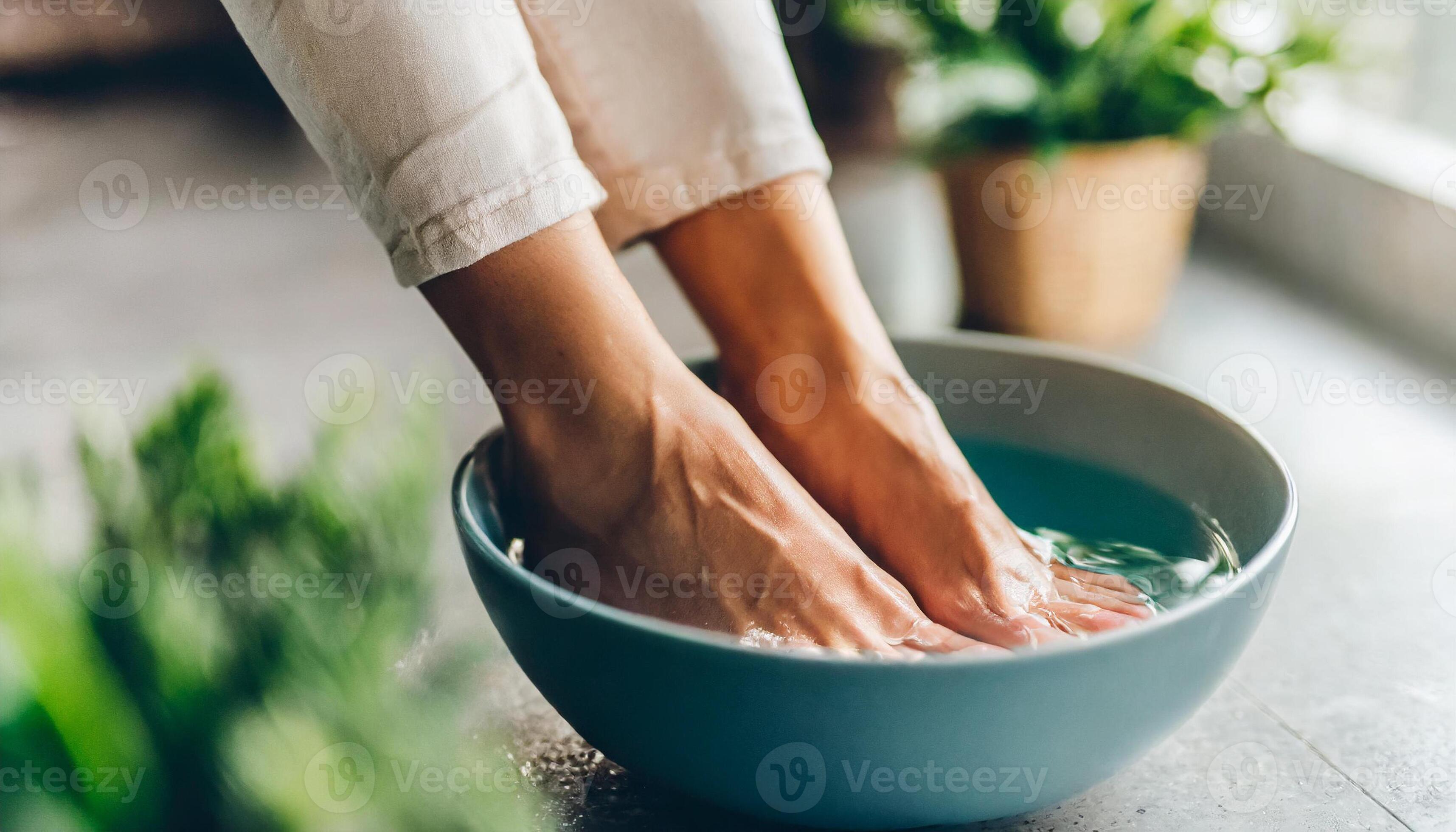 Womans Feet Submerged In A Bowl Of Water Showcasing Soft Clean Skin The Blurred Background