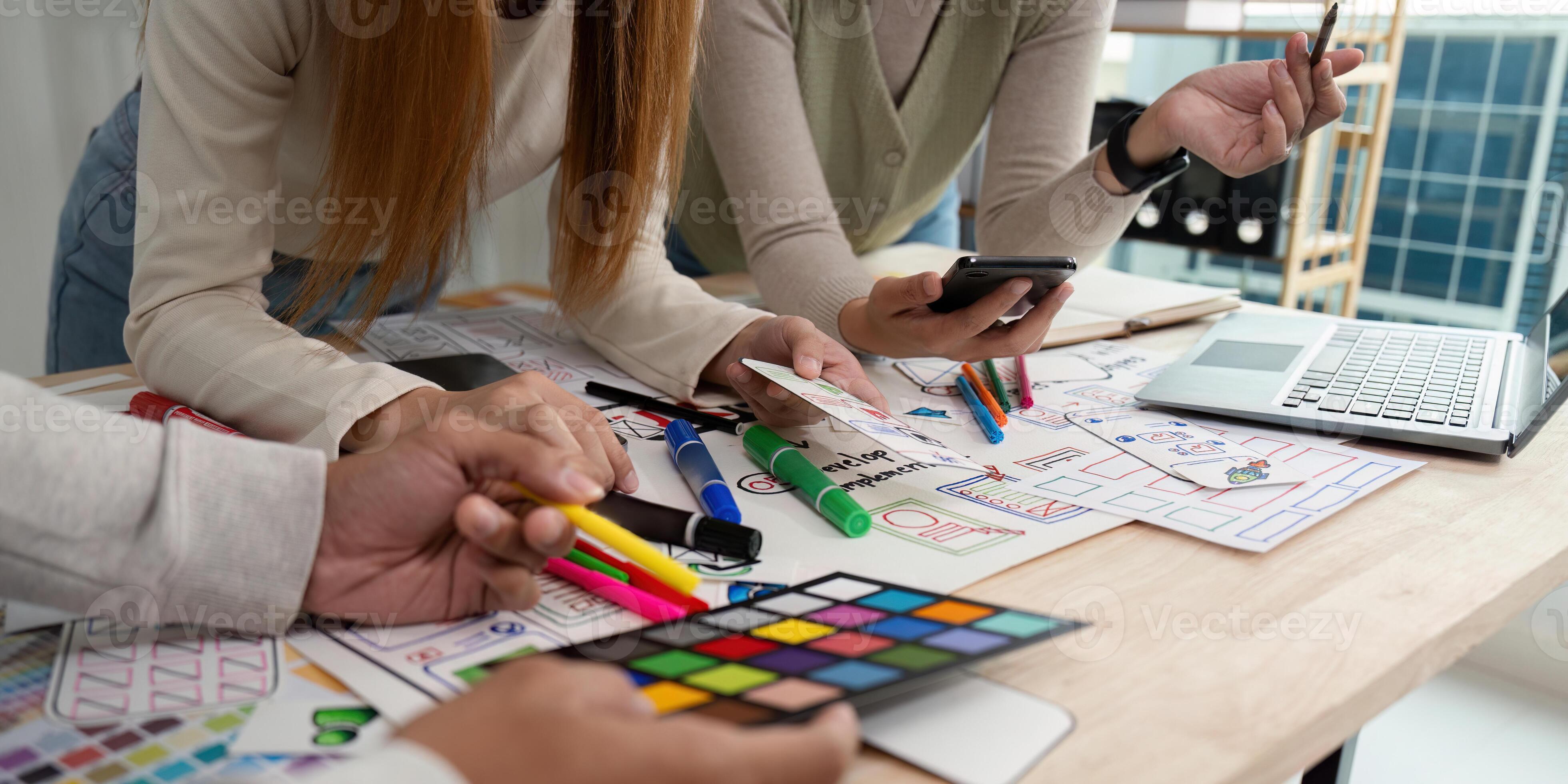 Creative Ux Developer And Ui Designer Brainstorming Session With Color Palettes And Wireframes