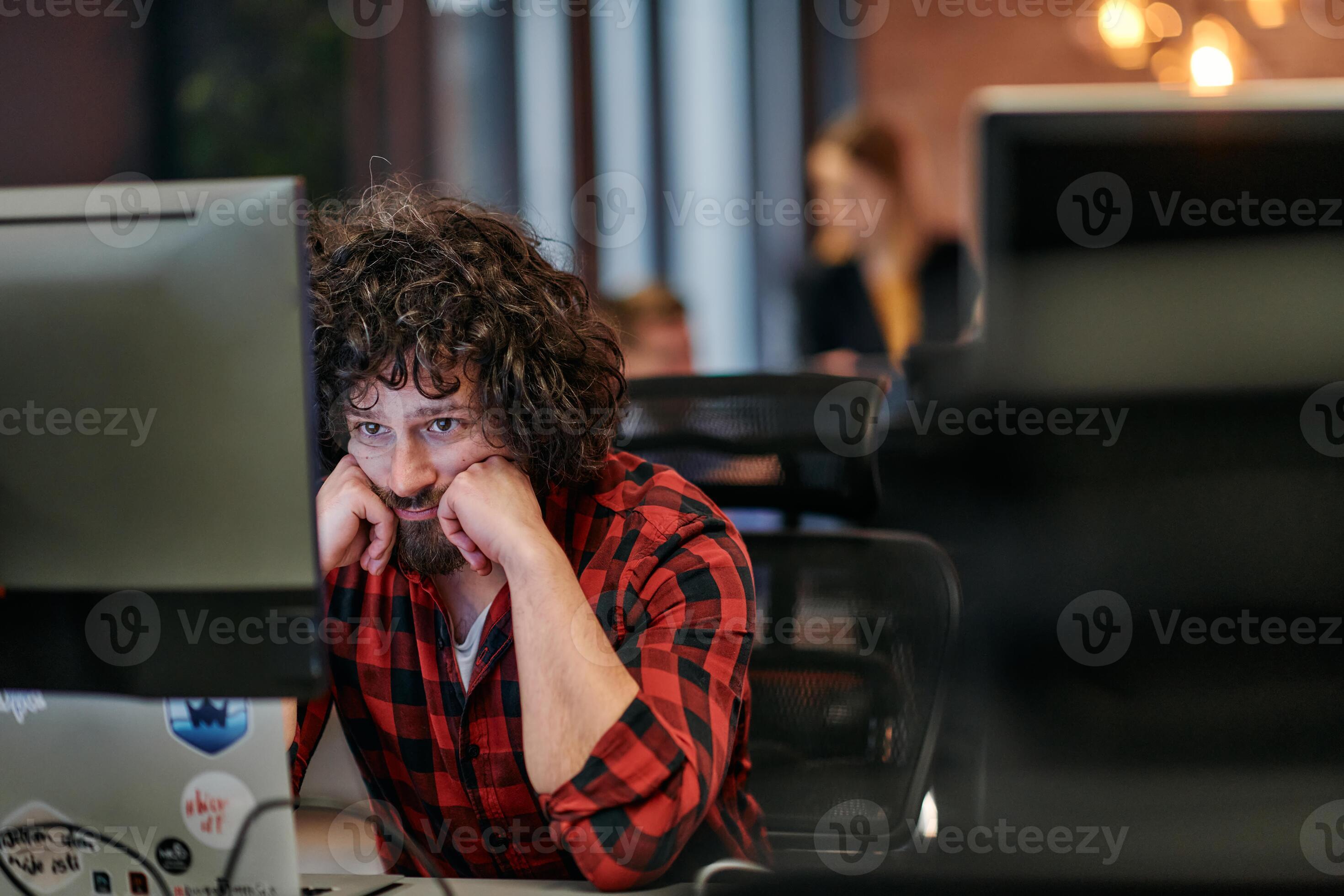 Disappointed Programmer with Messy Hair Looking at Computer Monitor in ...