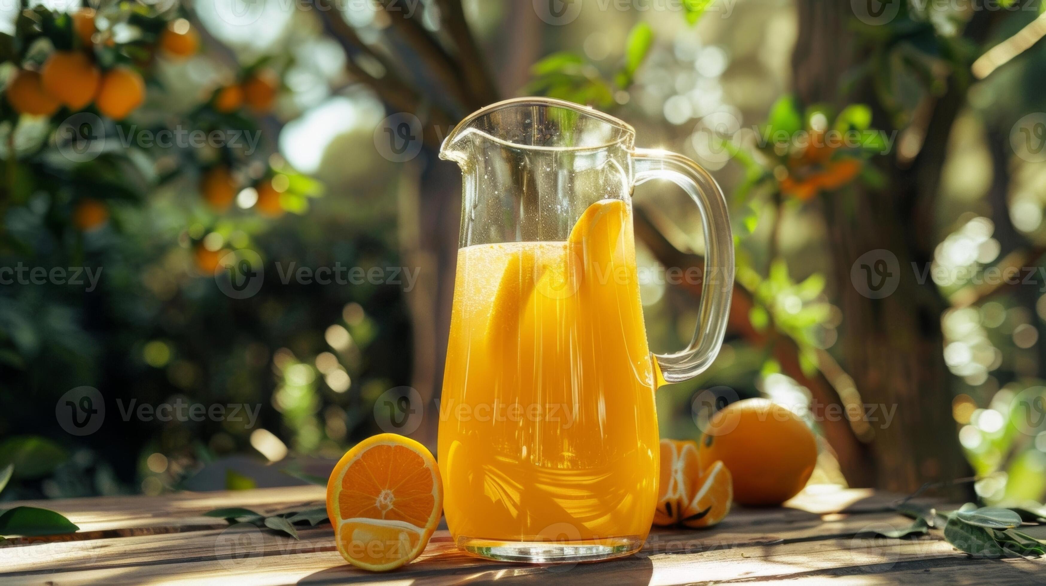 A tall glass pitcher filled with freshly squeezed orange juice from the nearby orchard 47253919 ...