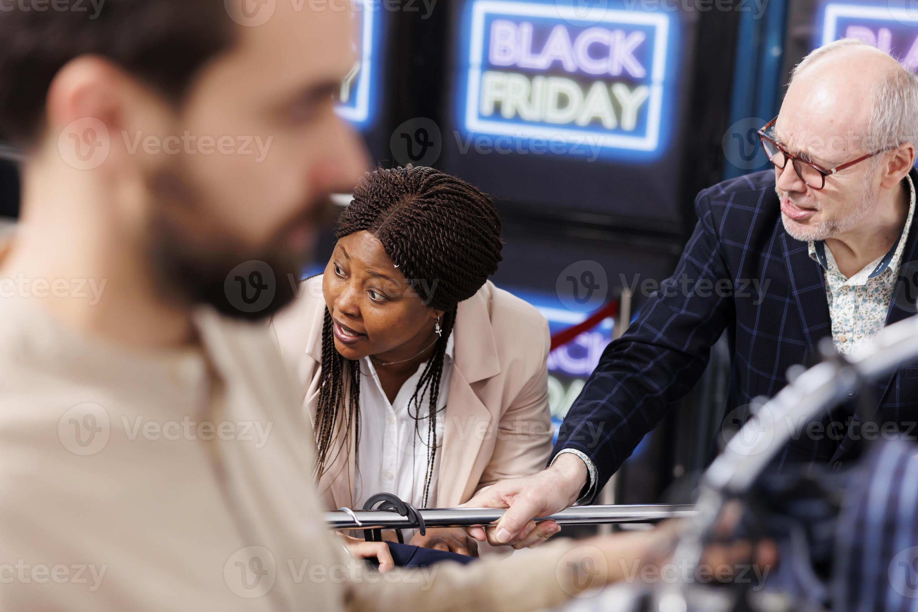 Rude unpleasant shoppers arguing and fighting while hunting for Black Friday deals in clothing ...