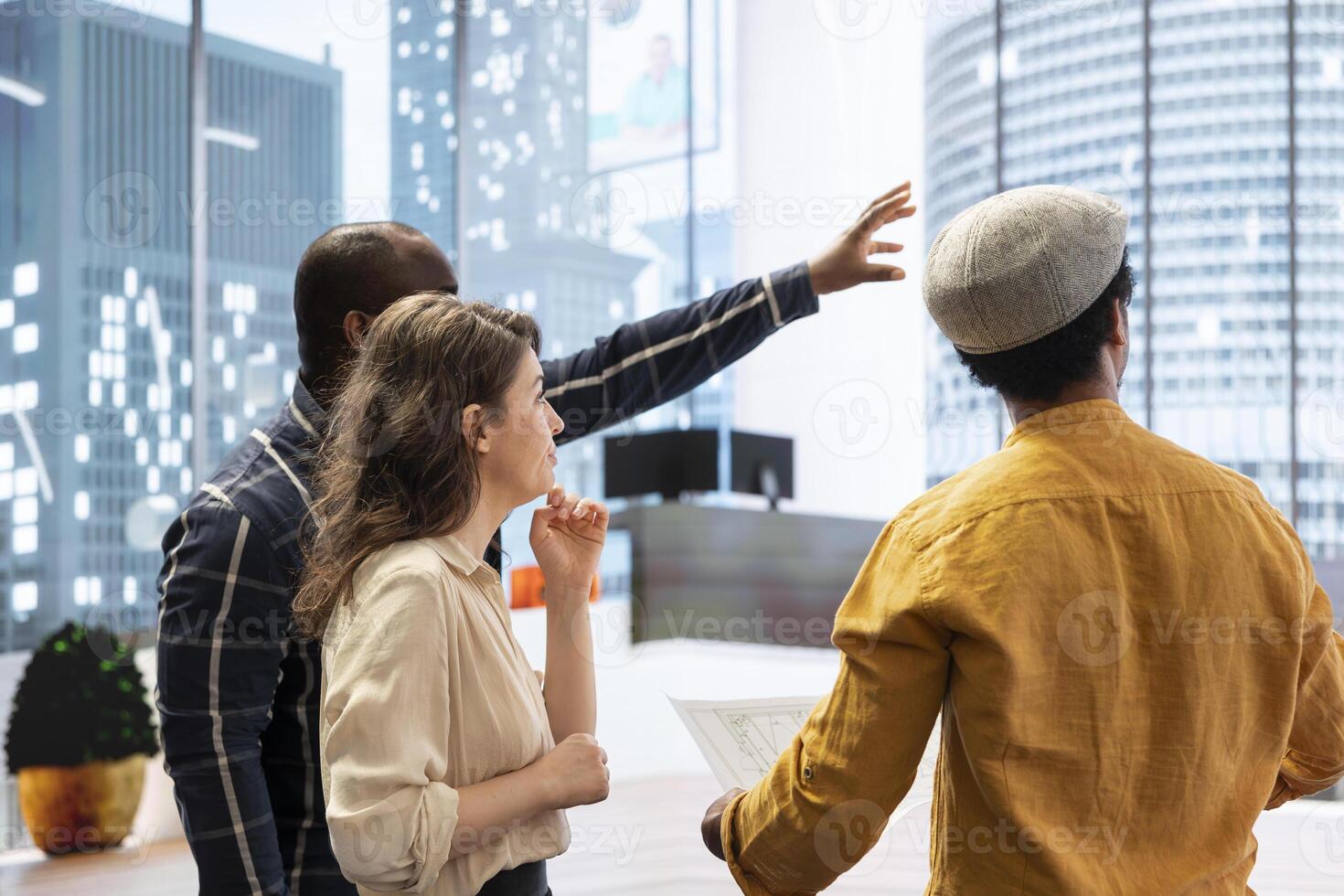 Realtor And Clients Sharing Workspace Design Vision On An Office Tour