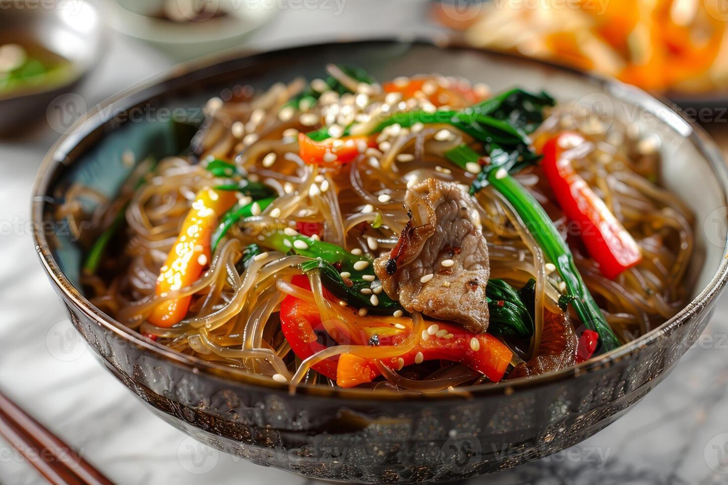 Jap chae noodle Korean with chicken and vegetables in a black plate 47378520 Stock Photo at Vecteezy