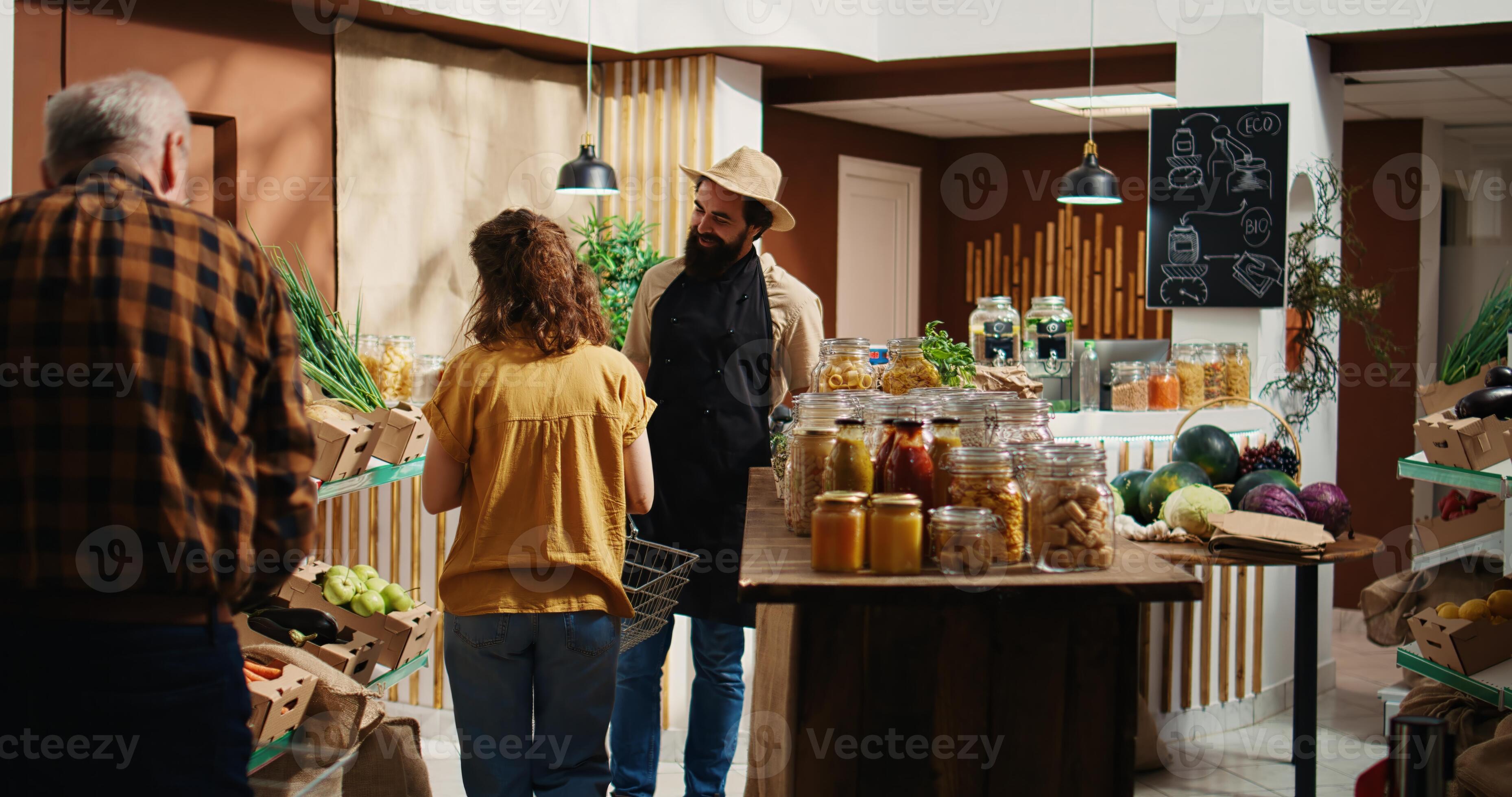 Owner greeting first customers at sustainable zero waste supermarket ... Owner greeting first customers at sustainable zero waste supermarket ...