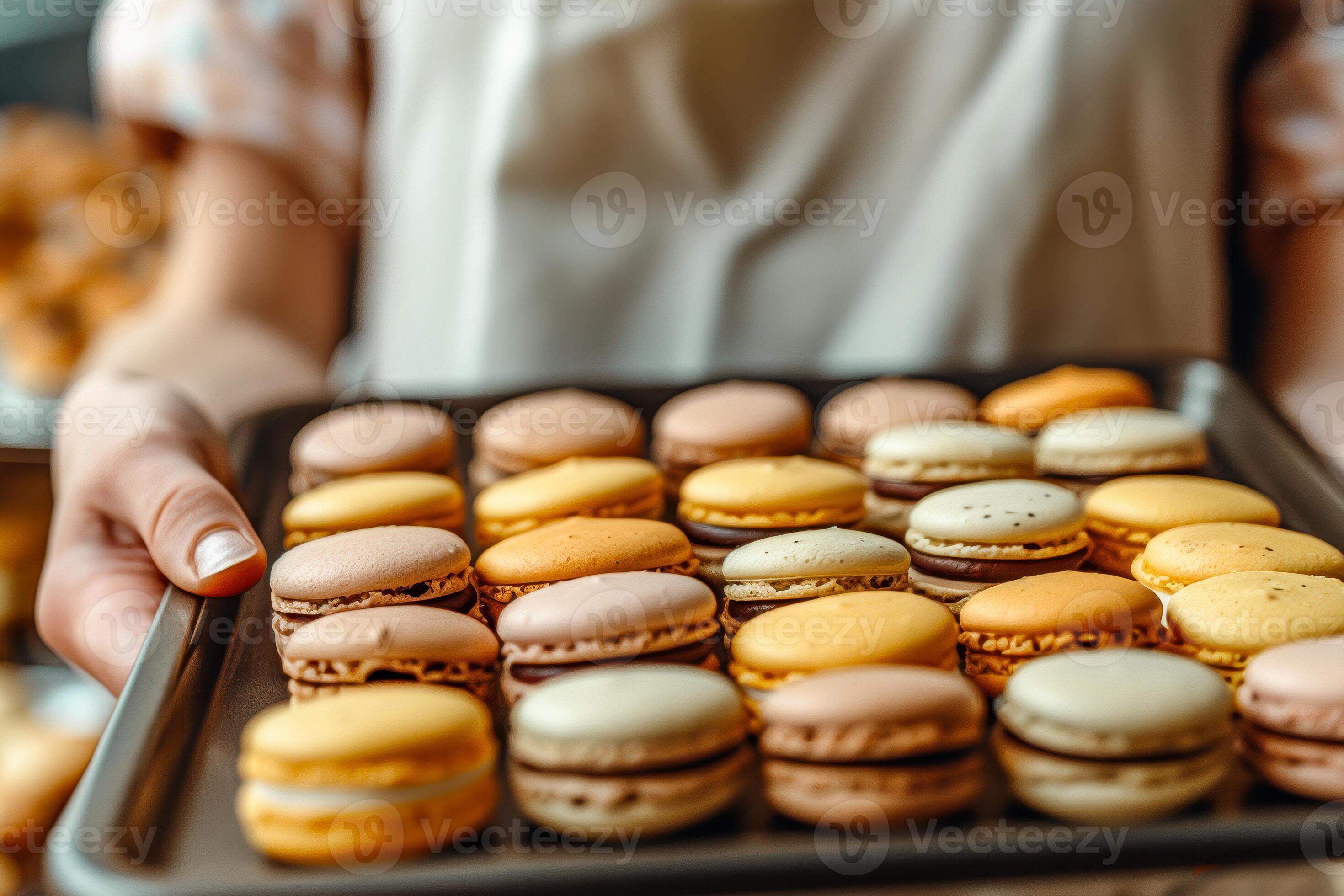 Baker is holding a baking sheet with macarons cookies, close up 47918669 Stock Photo at Vecteezy