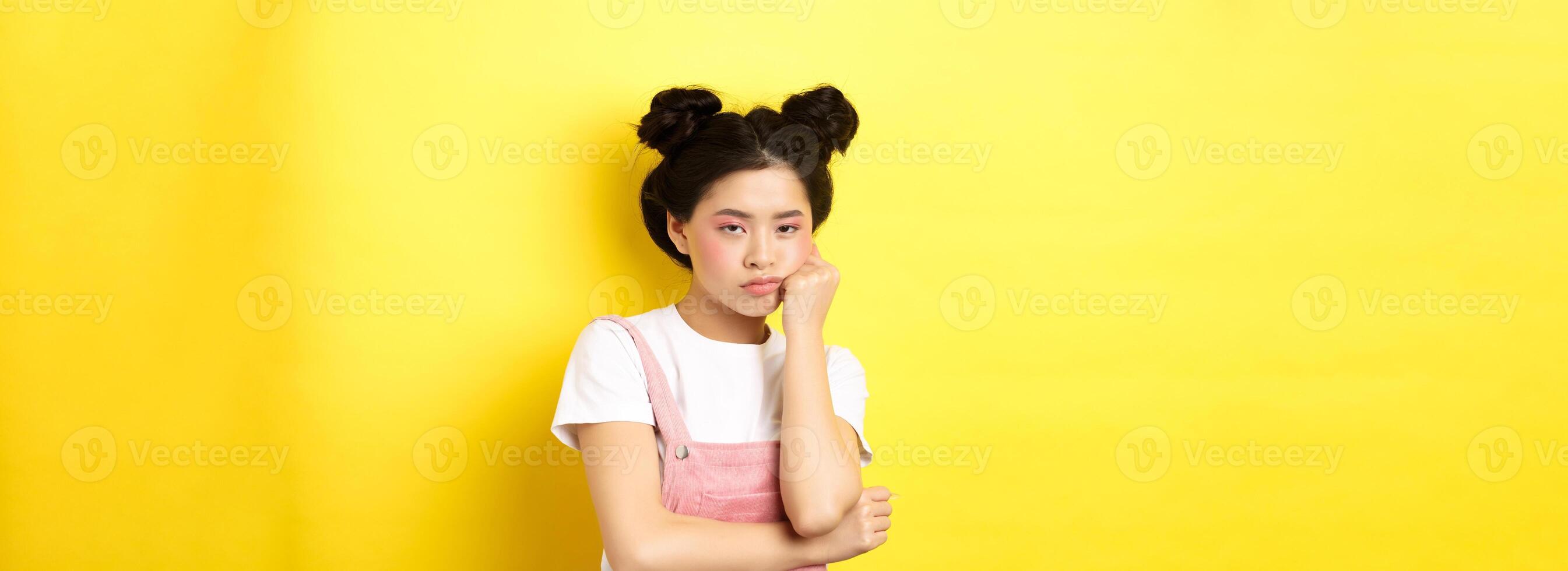 Bored asian teen girl with stylish makeup and summer clothes, looking ...