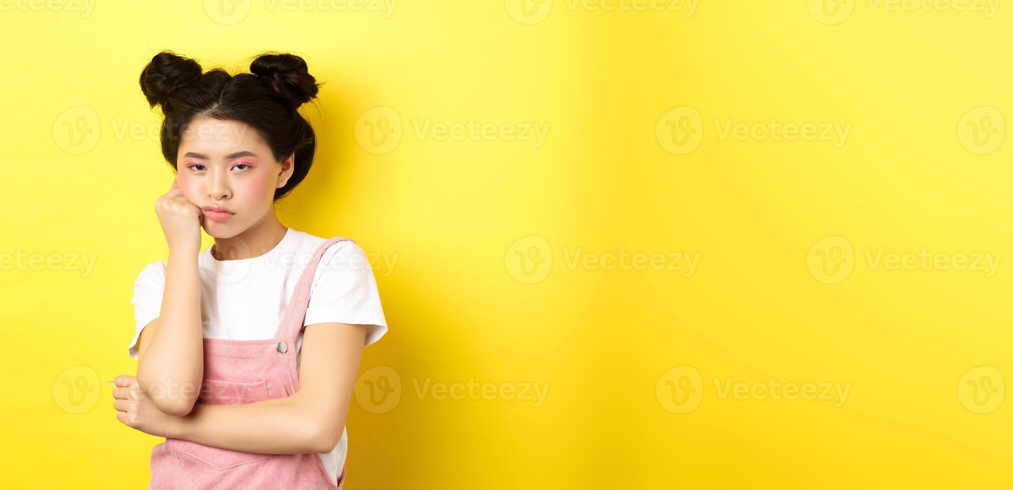 Bored asian teen girl with stylish makeup and summer clothes, looking ...