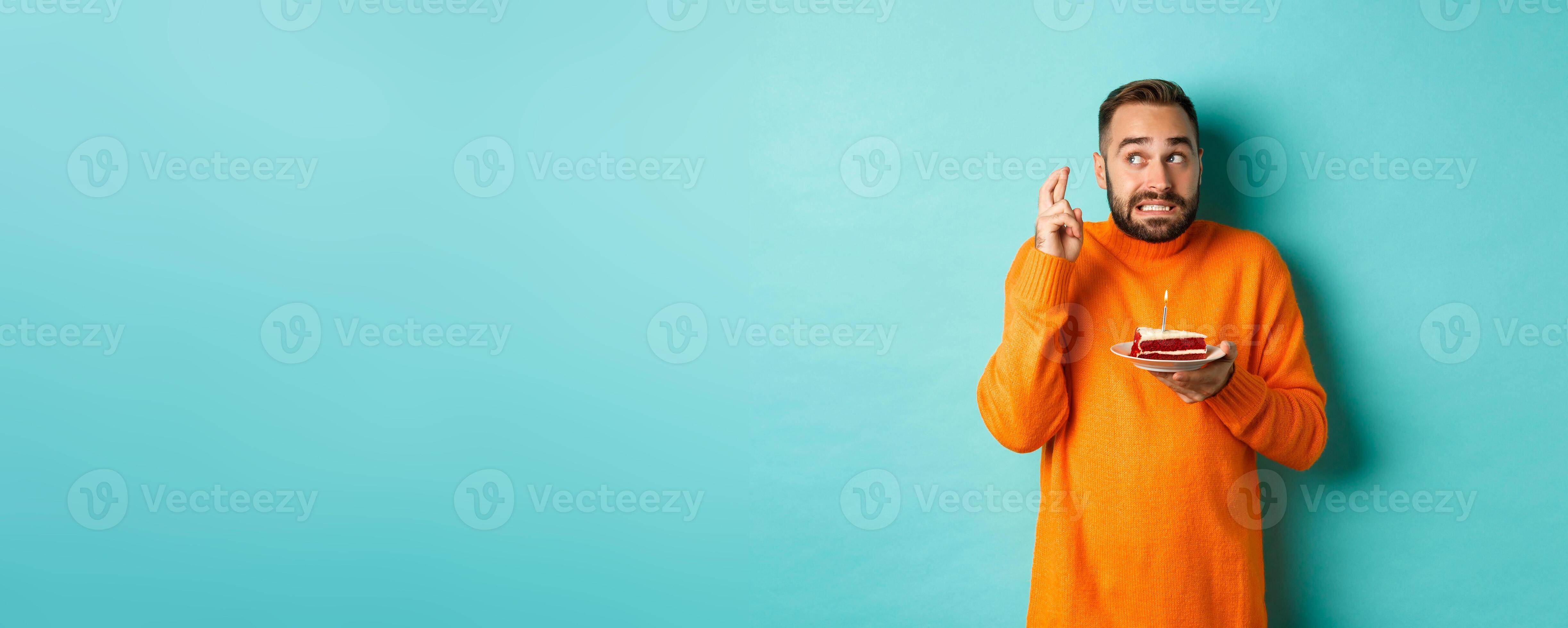 Handsome Adult Man Celebrating Birthday Blowing Out Candle On Cake And Making Wish Standing