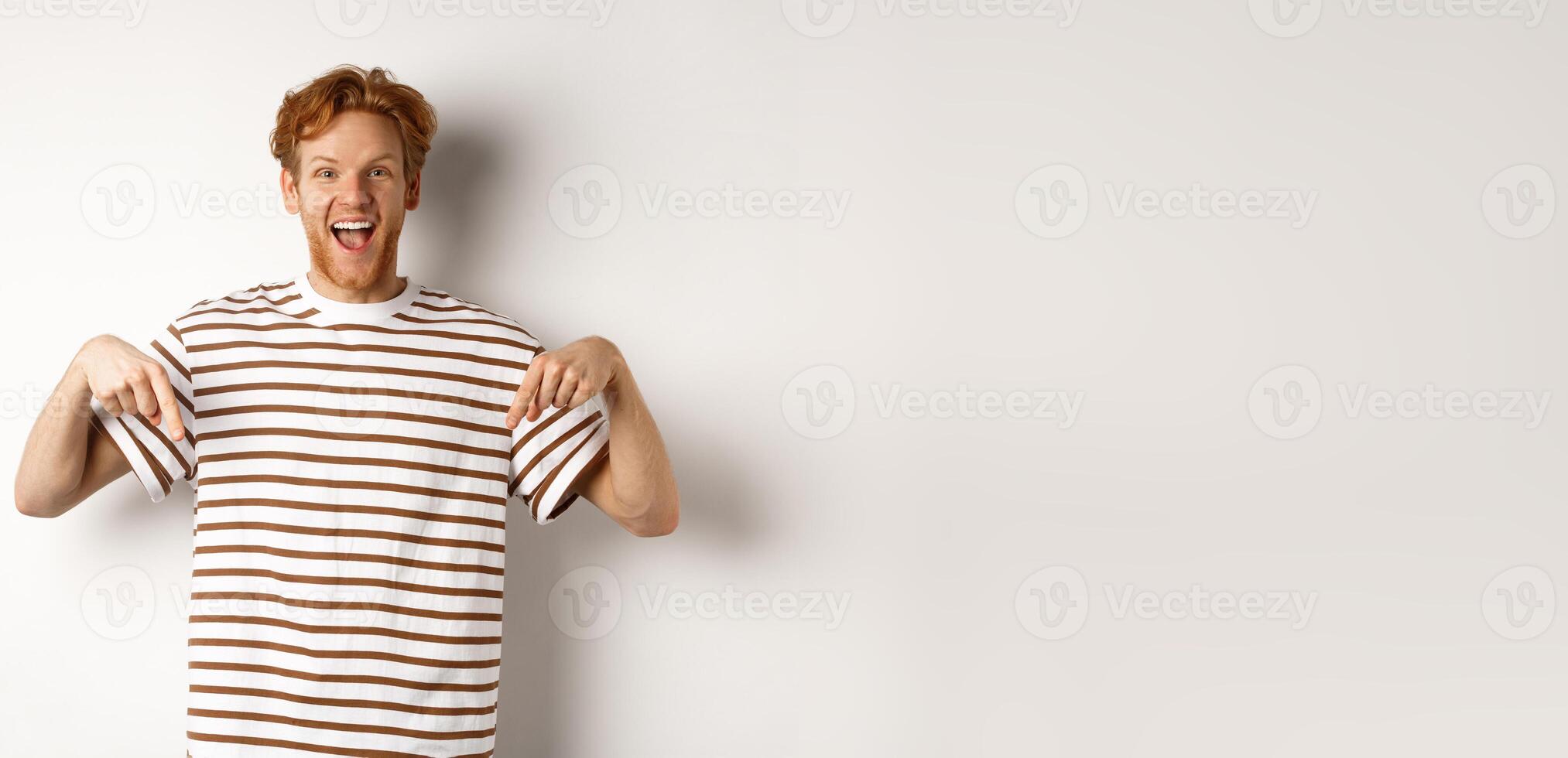 Enthusiastic Young Man With Ginger Hair And Bristle Showing