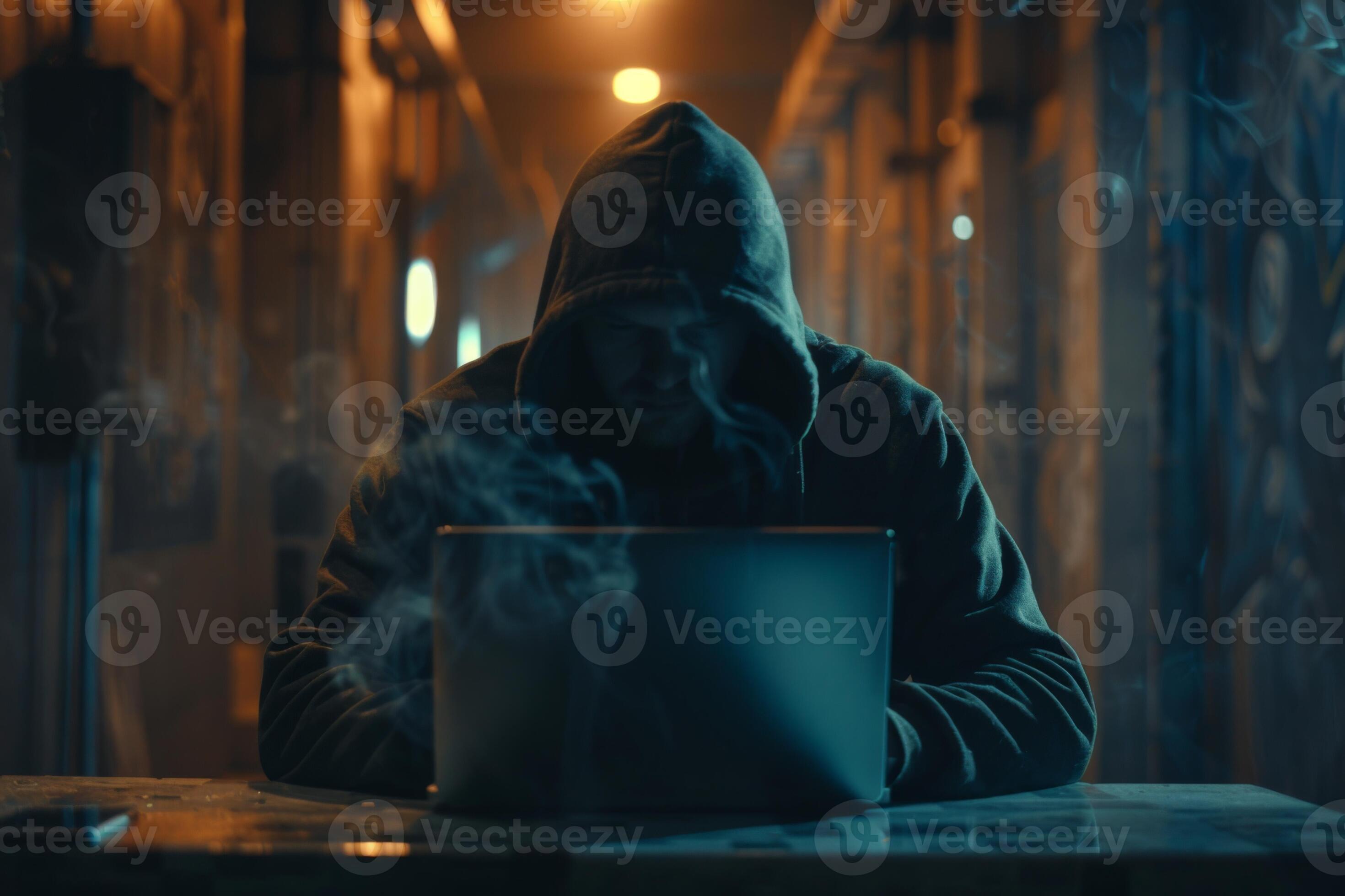Hacker In Hood Hacking At Computer In Dark Room Computer Criminal Uses Malware To Hack Devices