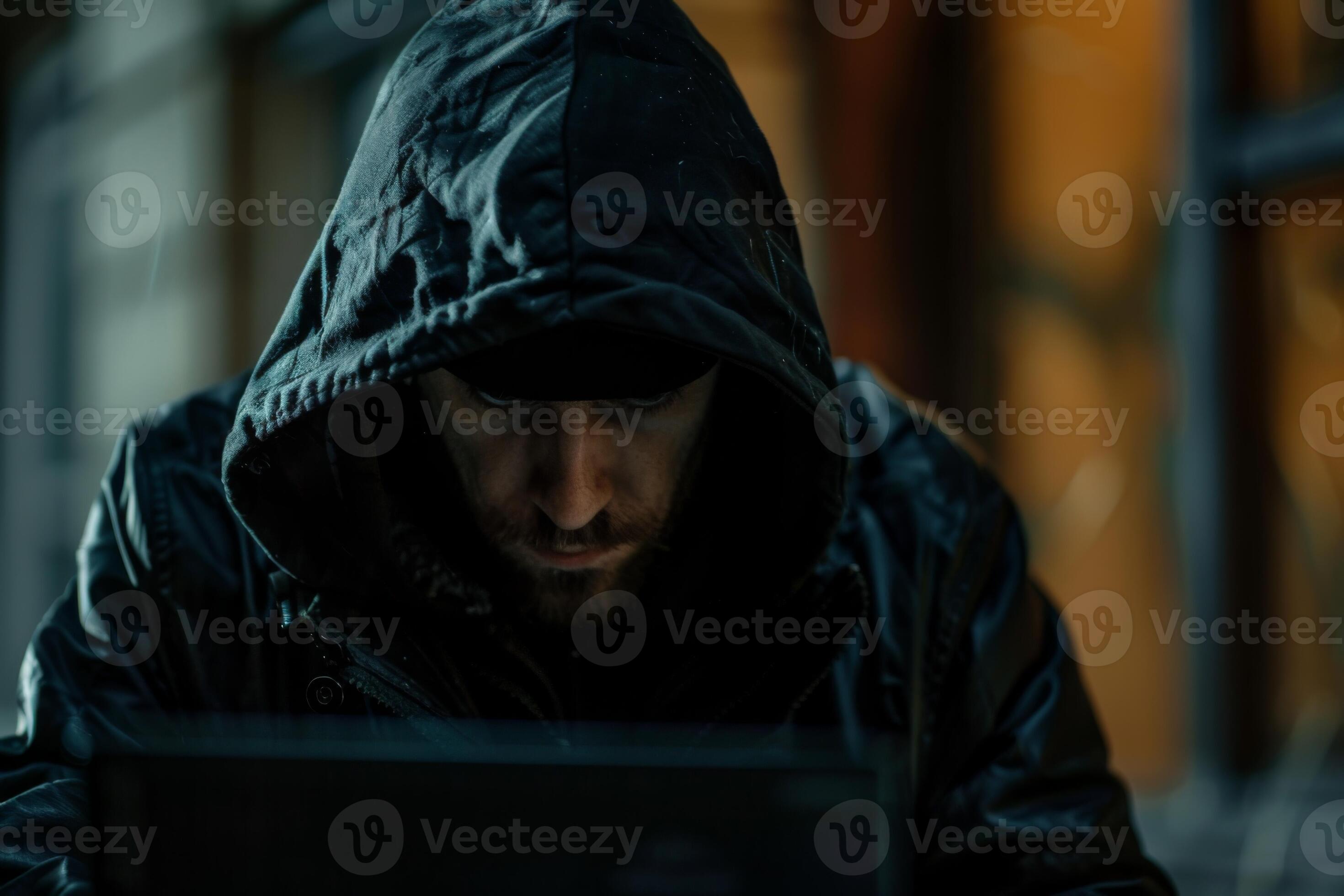 Hacker In Hood Hacking At Computer In Dark Room Computer Criminal Uses Malware To Hack Devices