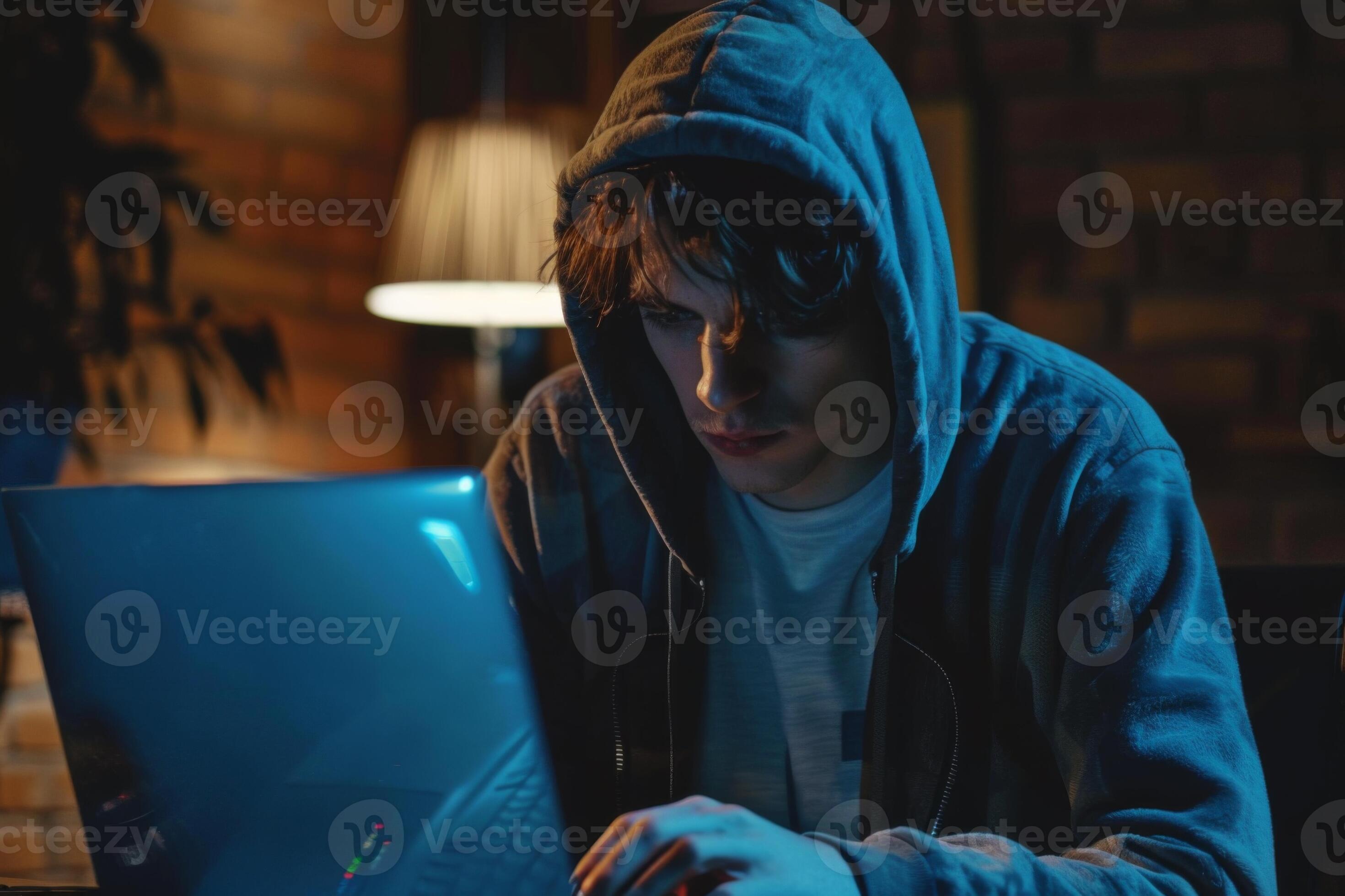 Hacker In Hood Hacking At Computer In Dark Room Computer Criminal Uses Malware To Hack Devices