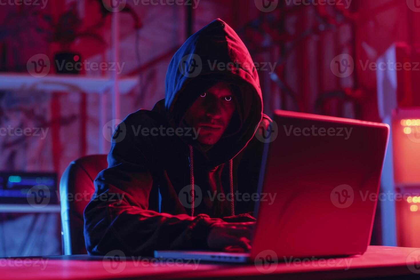 Hacker In Hood Hacking At Computer In Dark Room Computer Criminal Uses Malware To Hack Devices