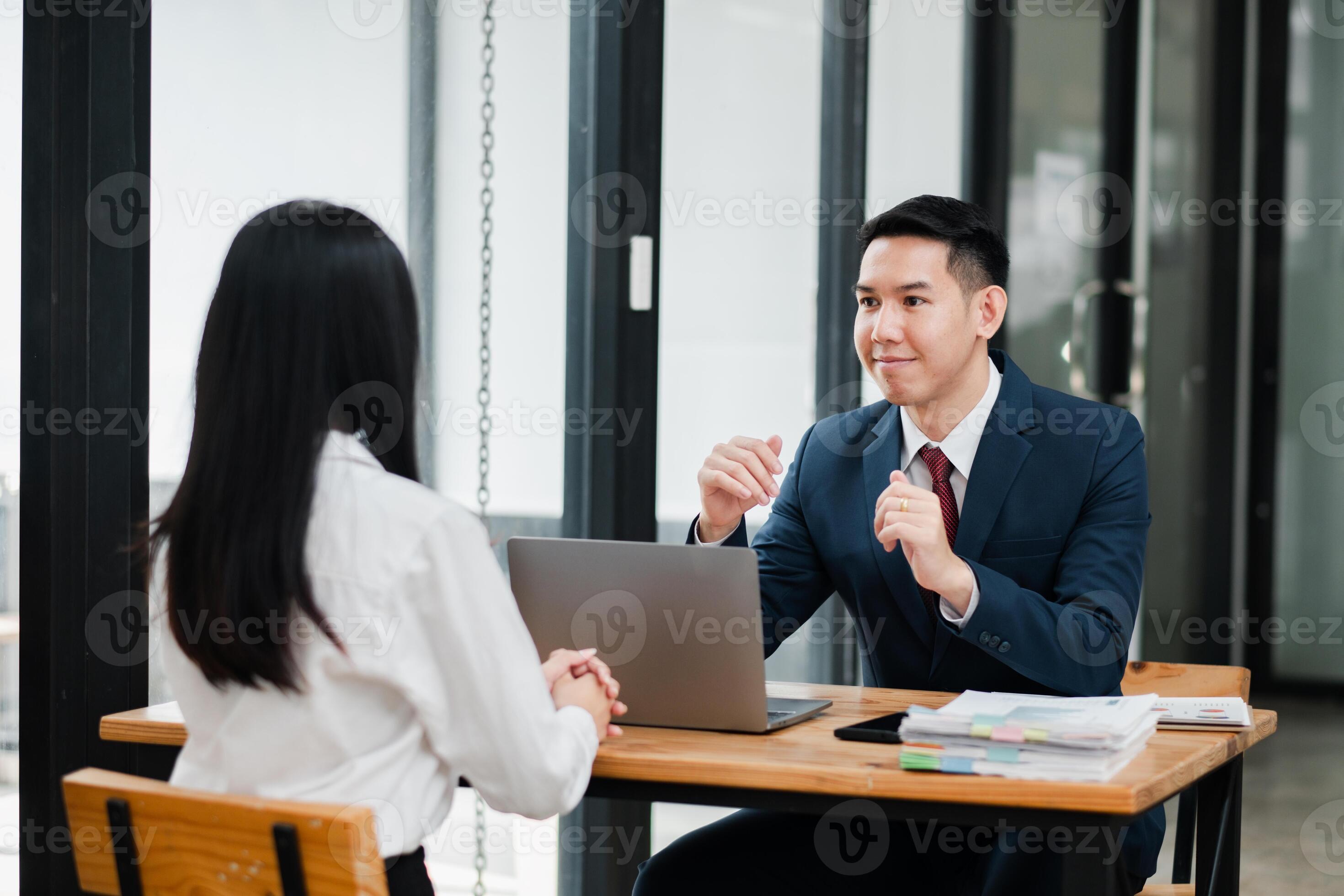 A professional business meeting between two colleagues in a modern ... A professional business meeting between two colleagues in a modern ...