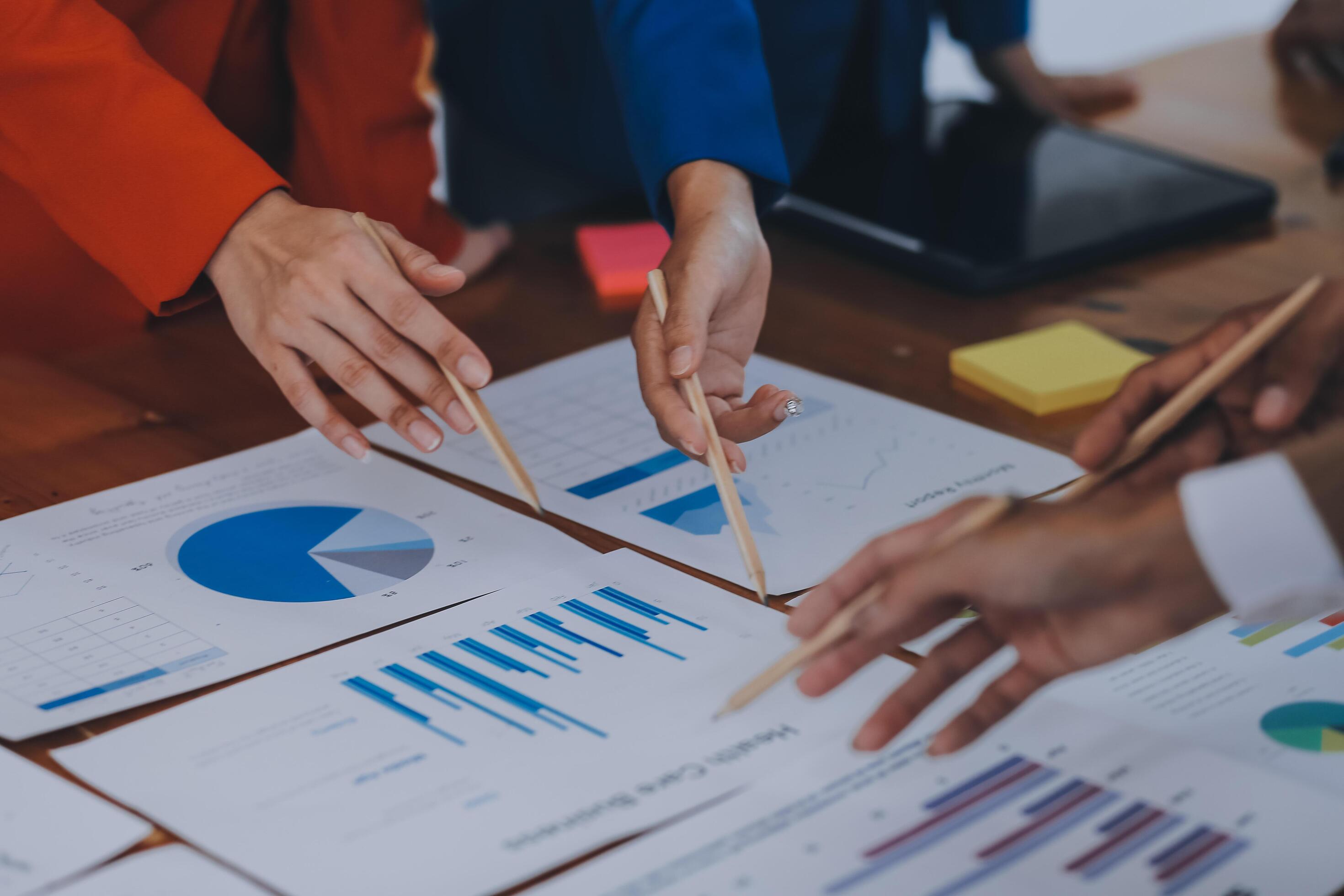 Business professionals. Group of young confident business people analyzing data using computer ...