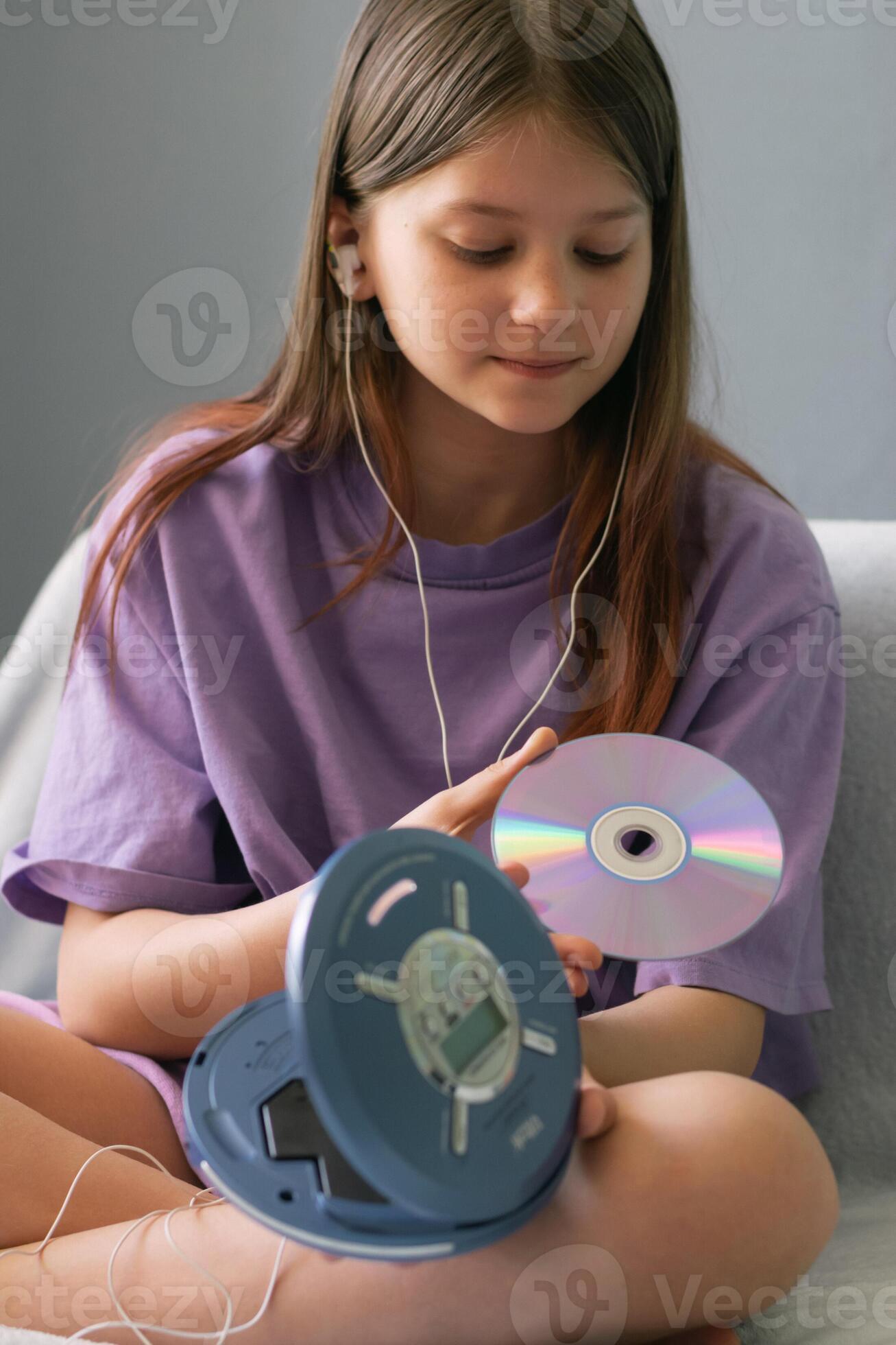 A Teenage Girl In A Lilac T Shirt Lies On A Bed And Listens To Music On