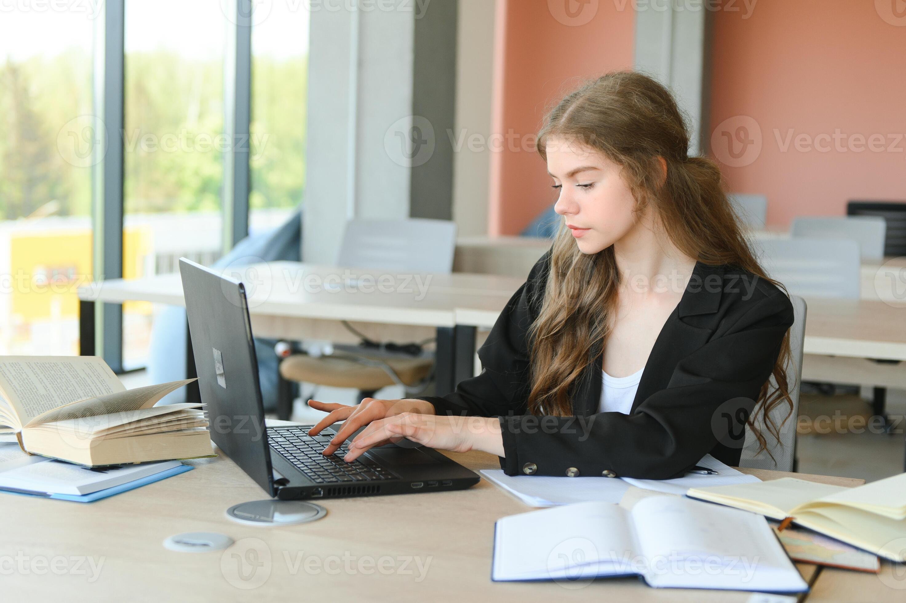 A cute schoolgirl is sitting at a desk at school. The concept of schooling. 48227709 Stock Photo ...