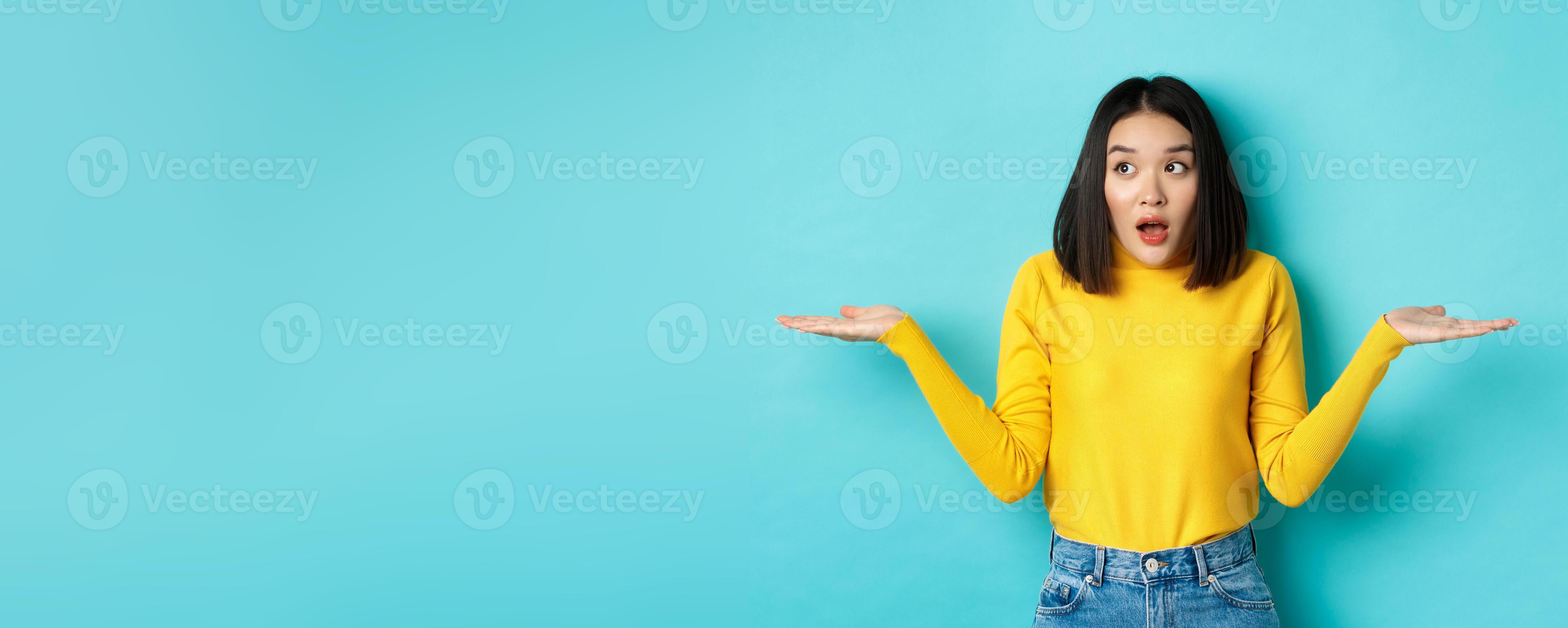 Confused and shocked asian woman dont understand, shrugging with spread ...