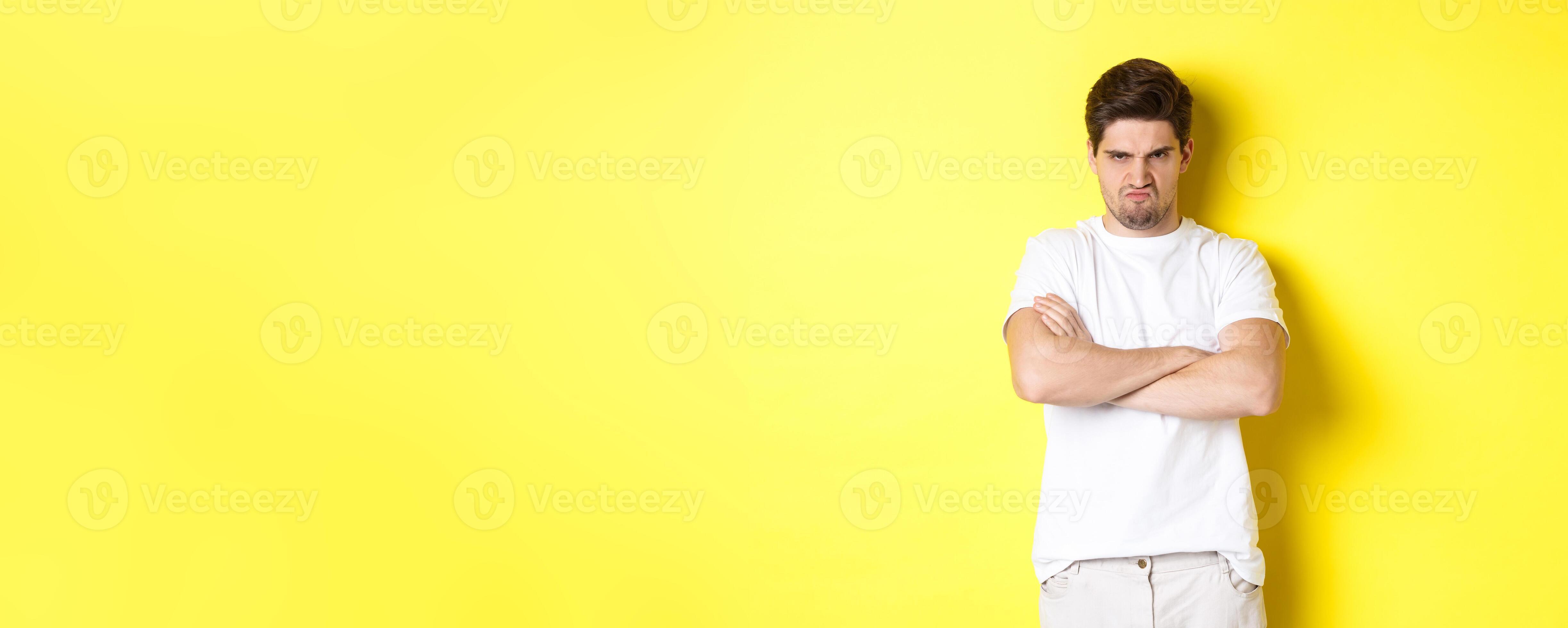 Offended And Mad Guy Frowning And Sulking Holding Hands Crossed On Chest Standing Angry