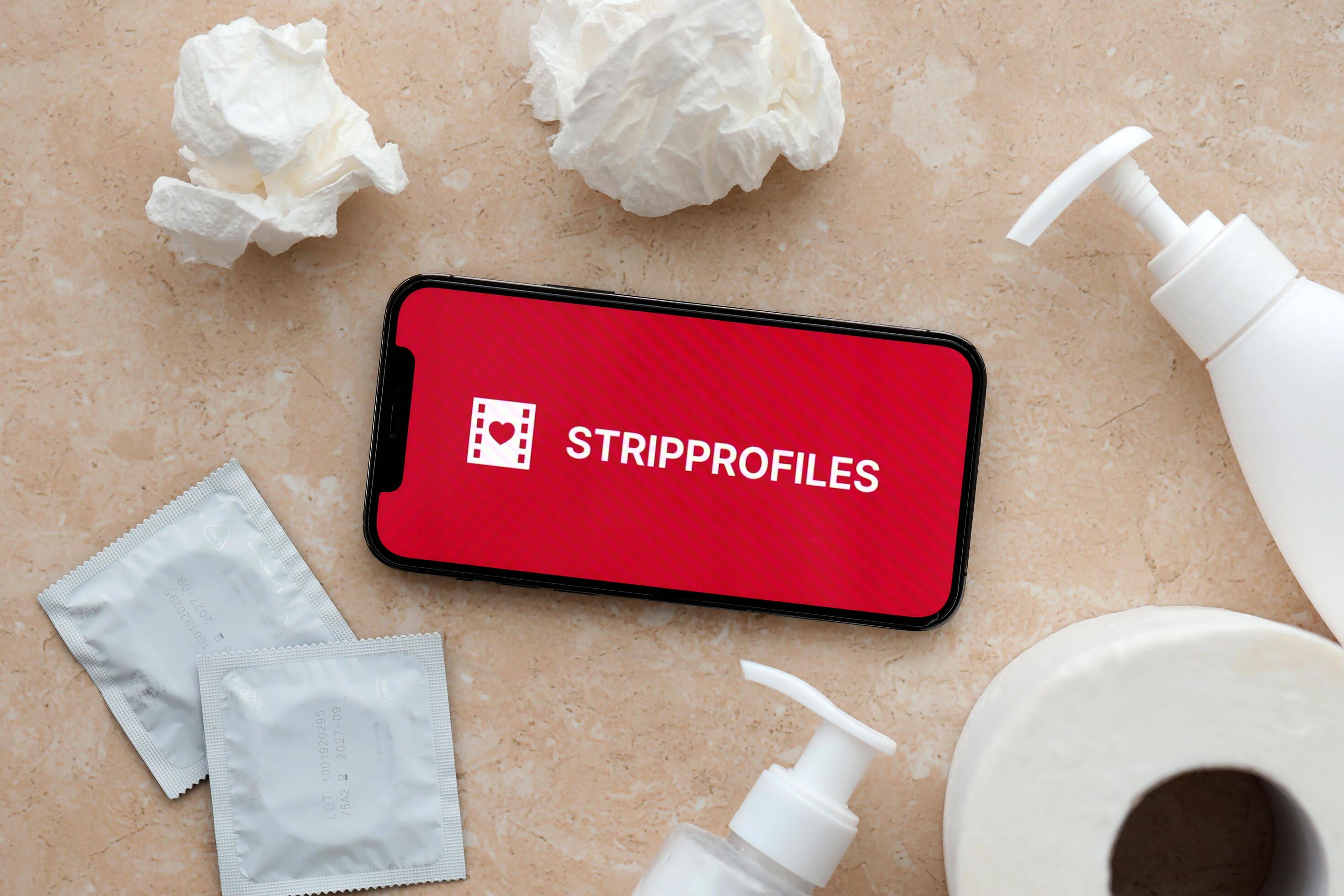 KYIV, UKRAINE - JANUARY 23, 2024 StripProfiles adult content website logo on display of iPhone ...