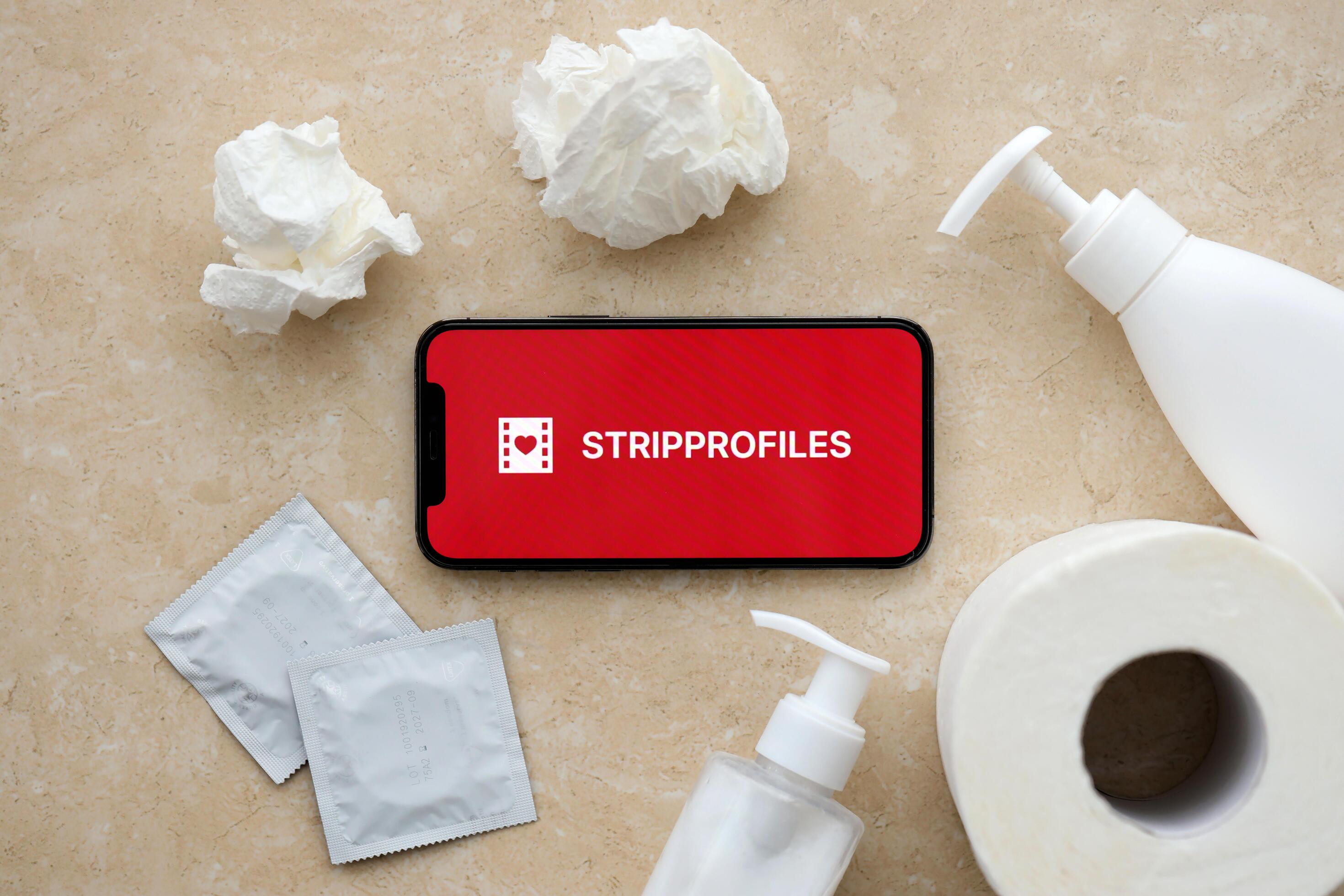 KYIV, UKRAINE - JANUARY 23, 2024 StripProfiles adult content website logo on display of iPhone ...