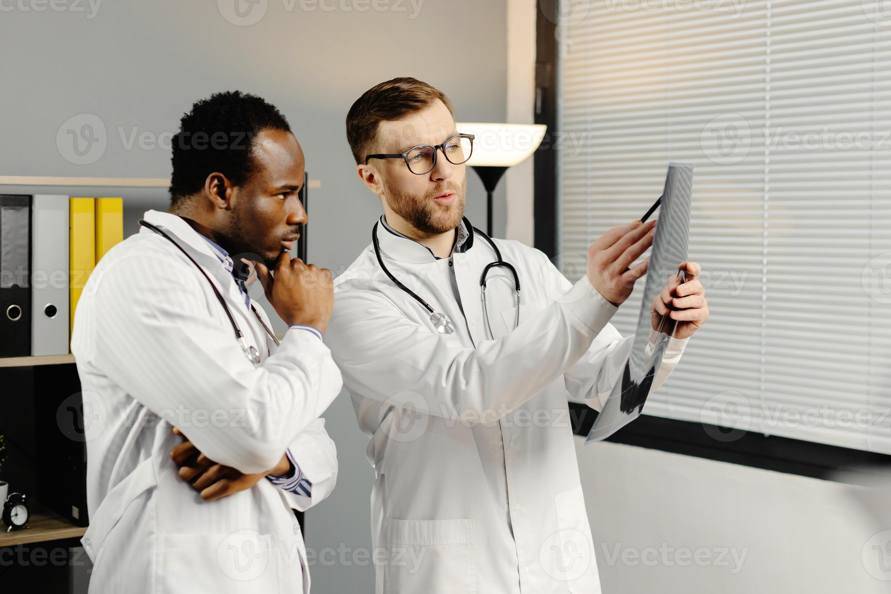 Two men in white lab coats analyzing xray 48430292 Stock Photo at Vecteezy