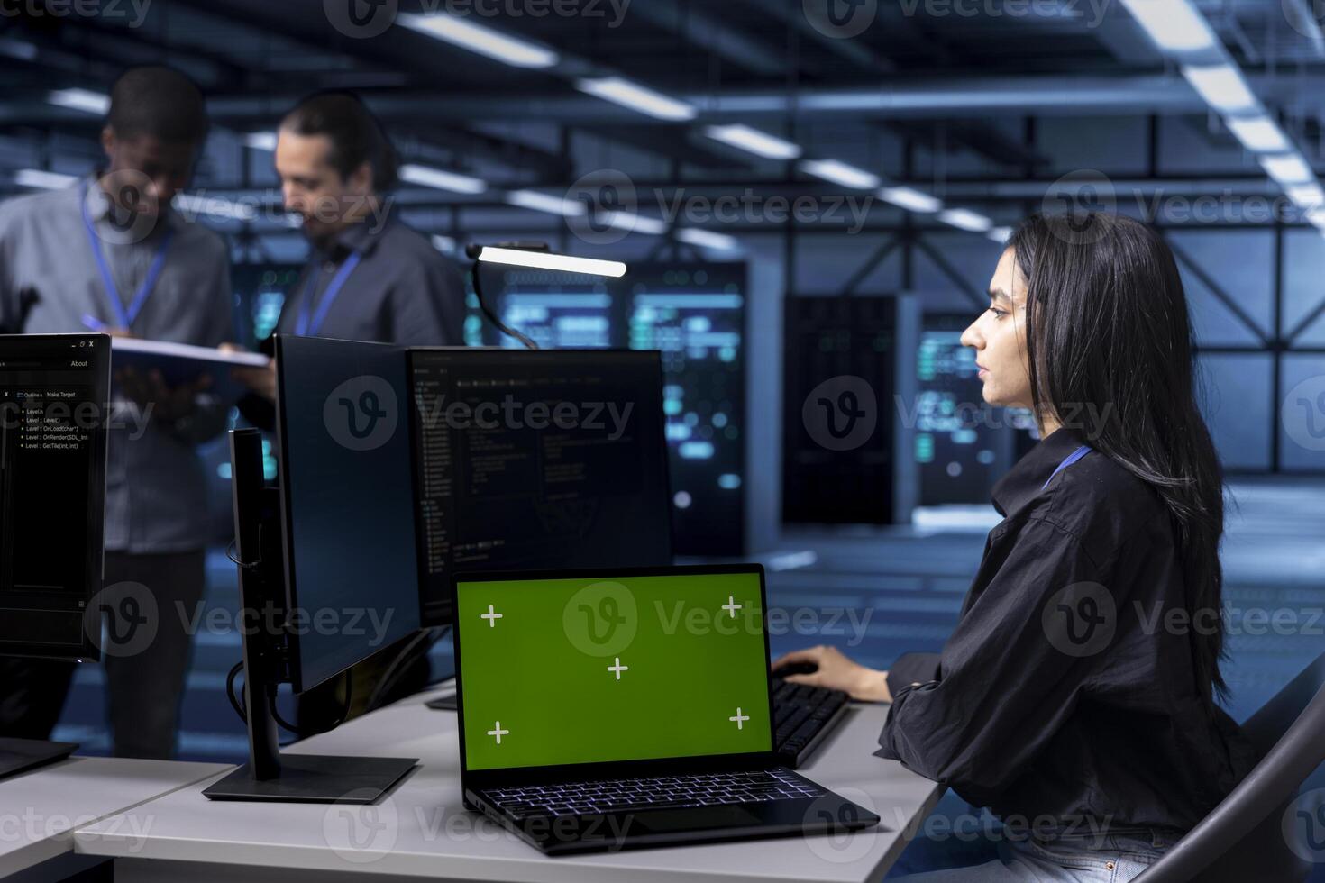 Computer Scientist Using Green Screen Notebook To Oversee Blade Servers Used For Managing