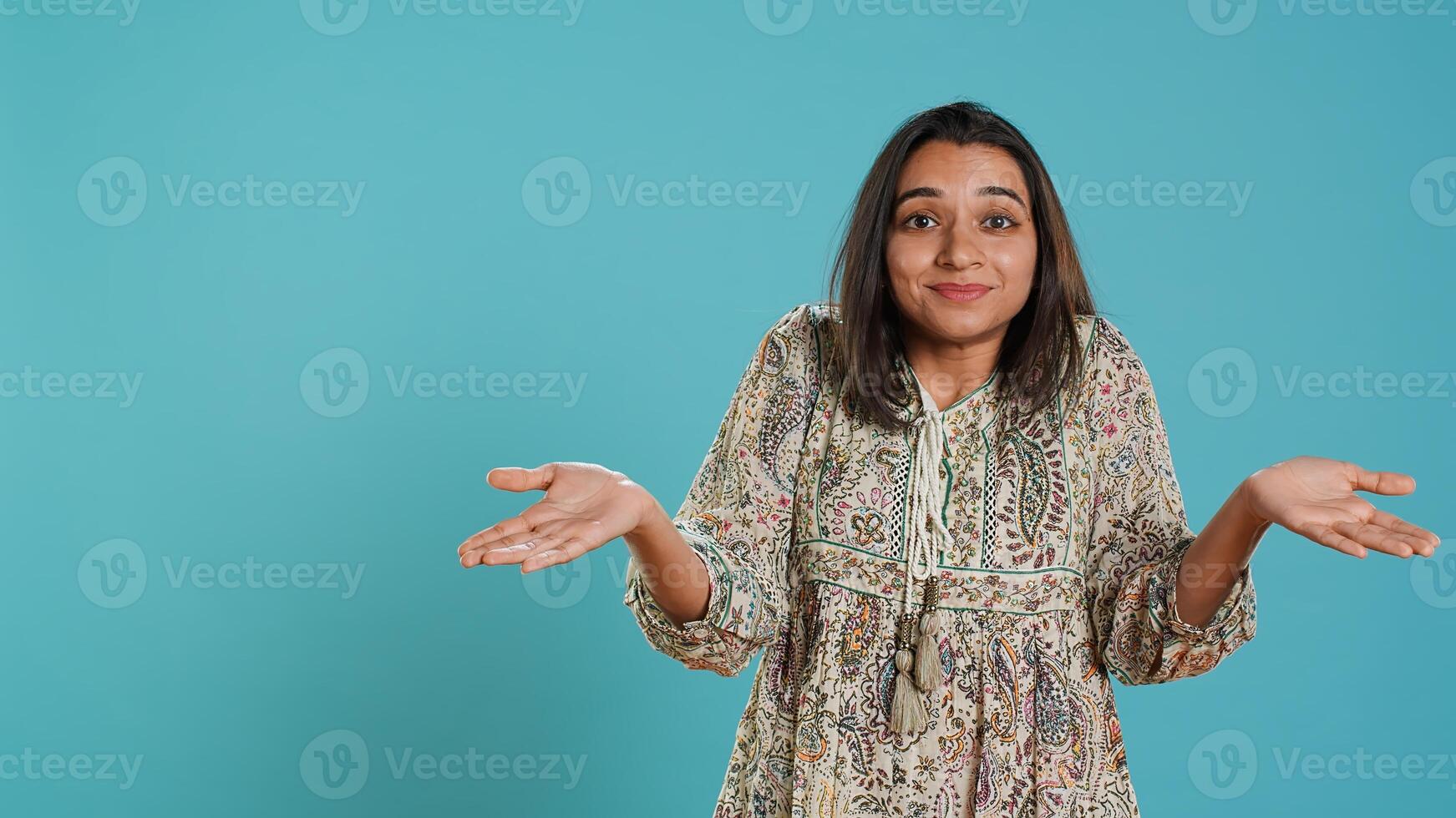 Indian woman shrugging shoulders, unable to provide answer, having ...