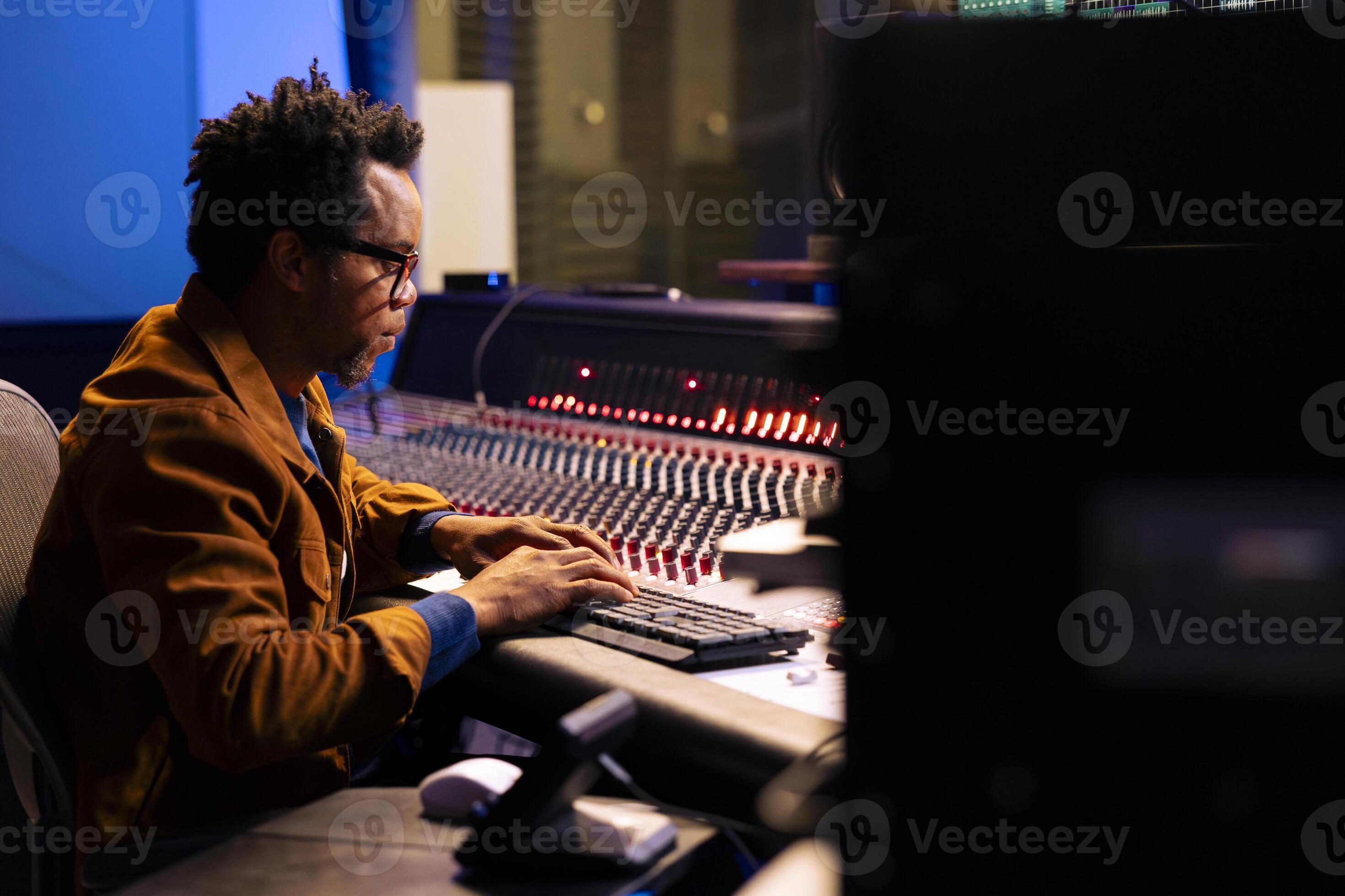 African american audio technician adding sound effects on recordings in ... African american audio technician adding sound effects on recordings in ...