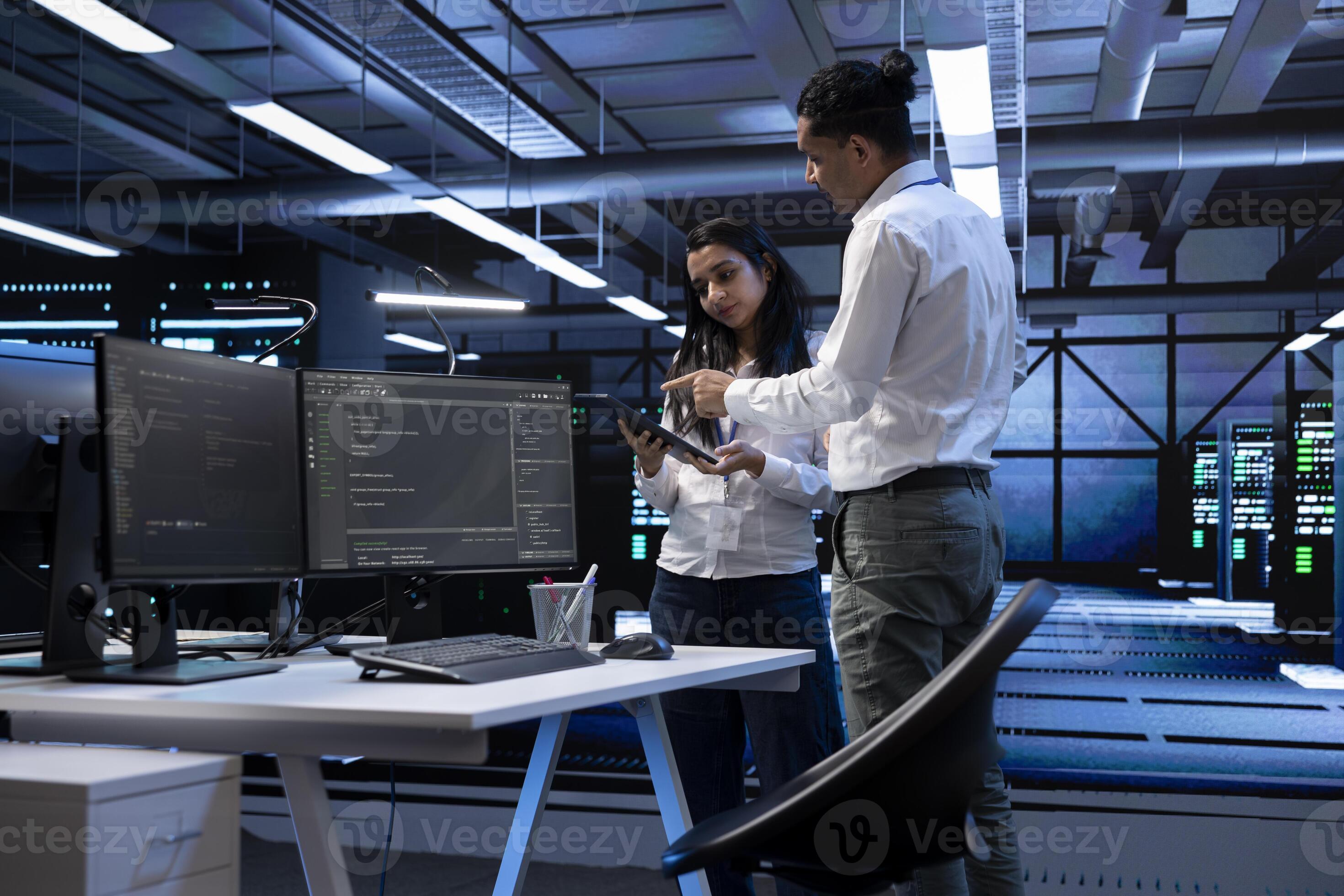 Tablet used by team of programmers in server room to find network issues affecting supercomputer ...