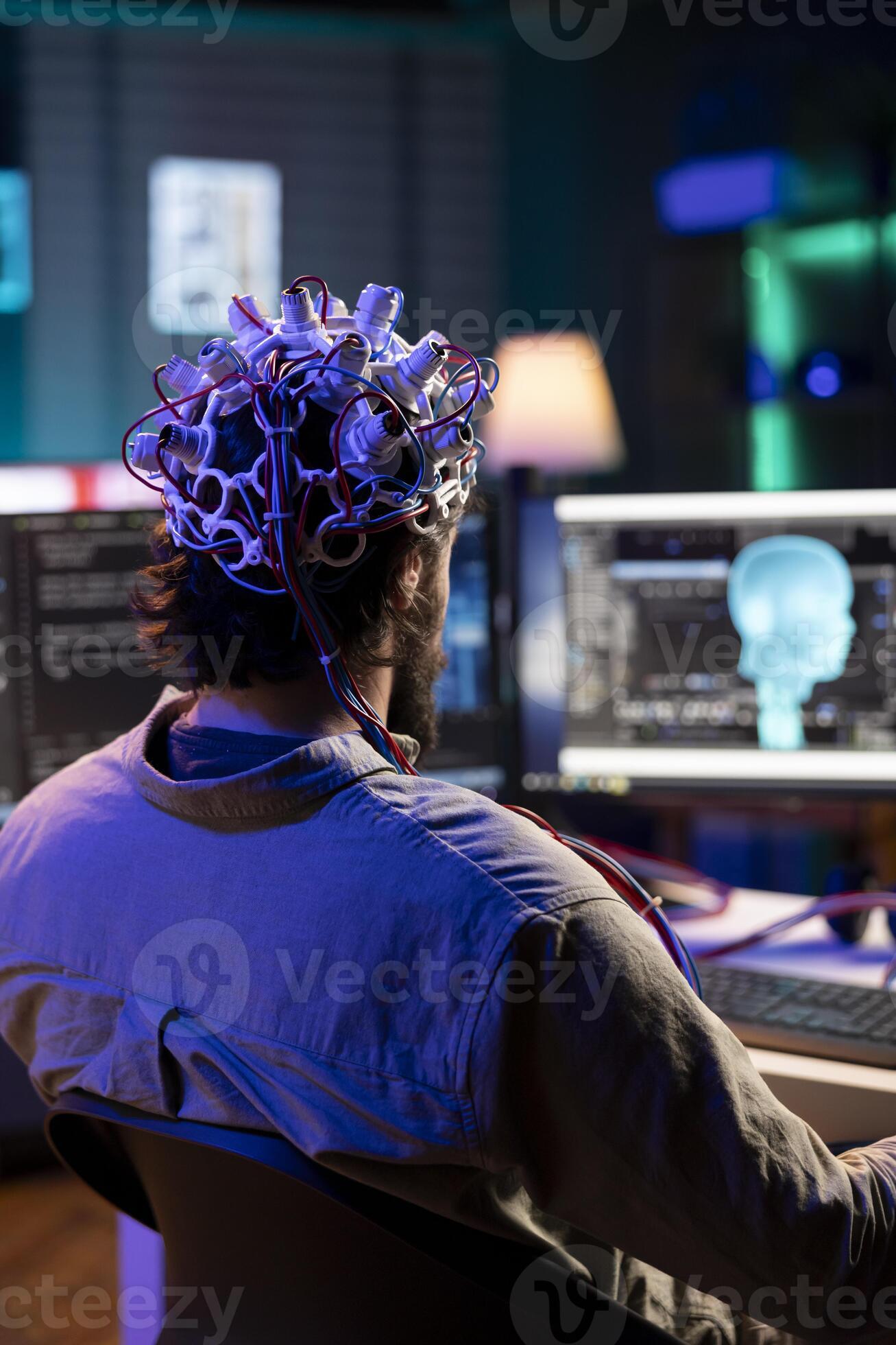 Software engineer using EEG headset translating thoughts into PC commands using brainwave ...