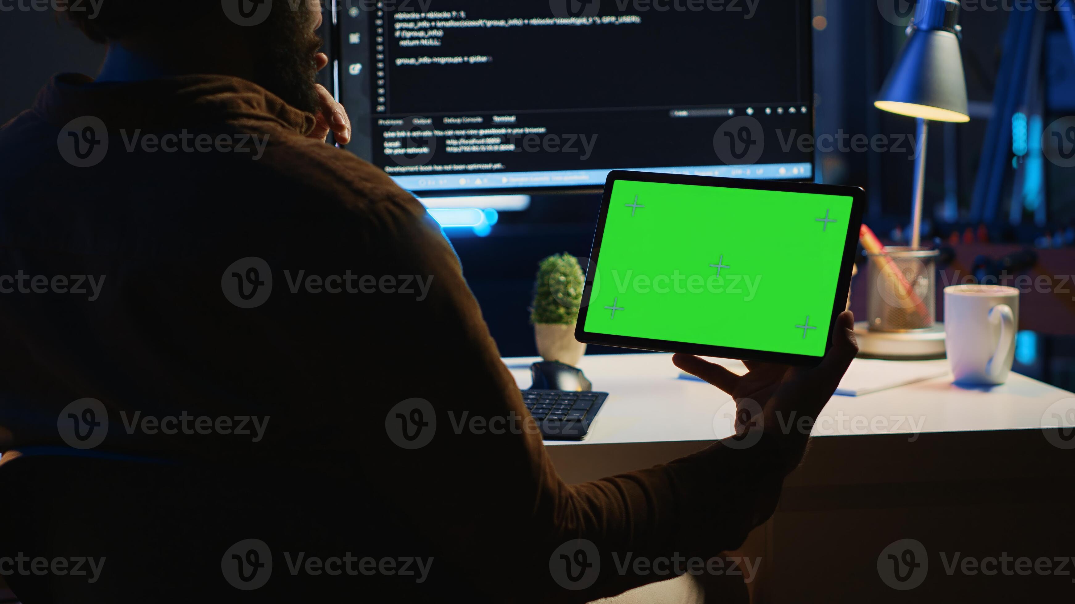 Software developer watching programming tutorial on isolated screen tablet in home office. Man ...