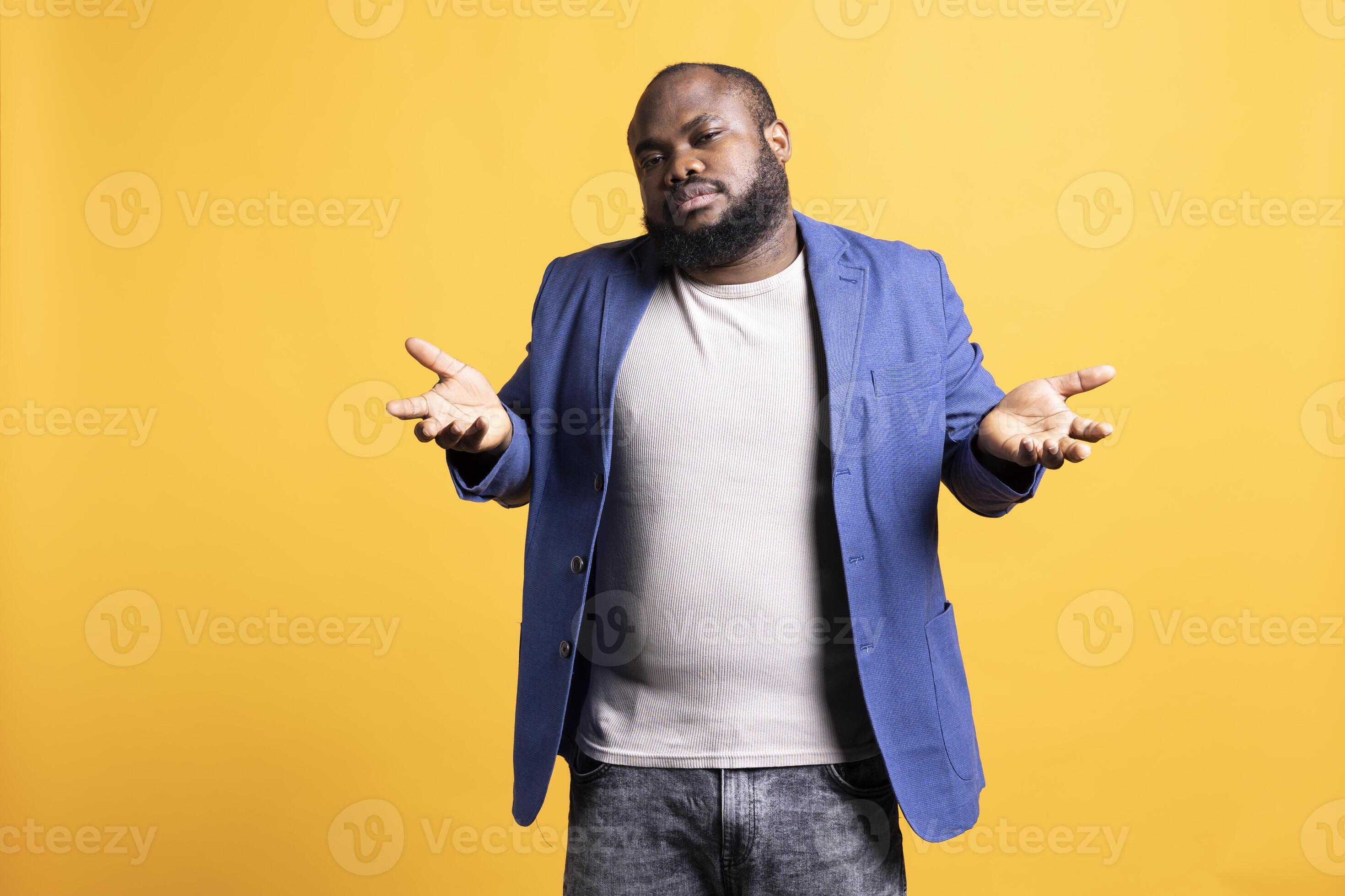 Uncaring african american man shrugging shoulders, showing indifference ...