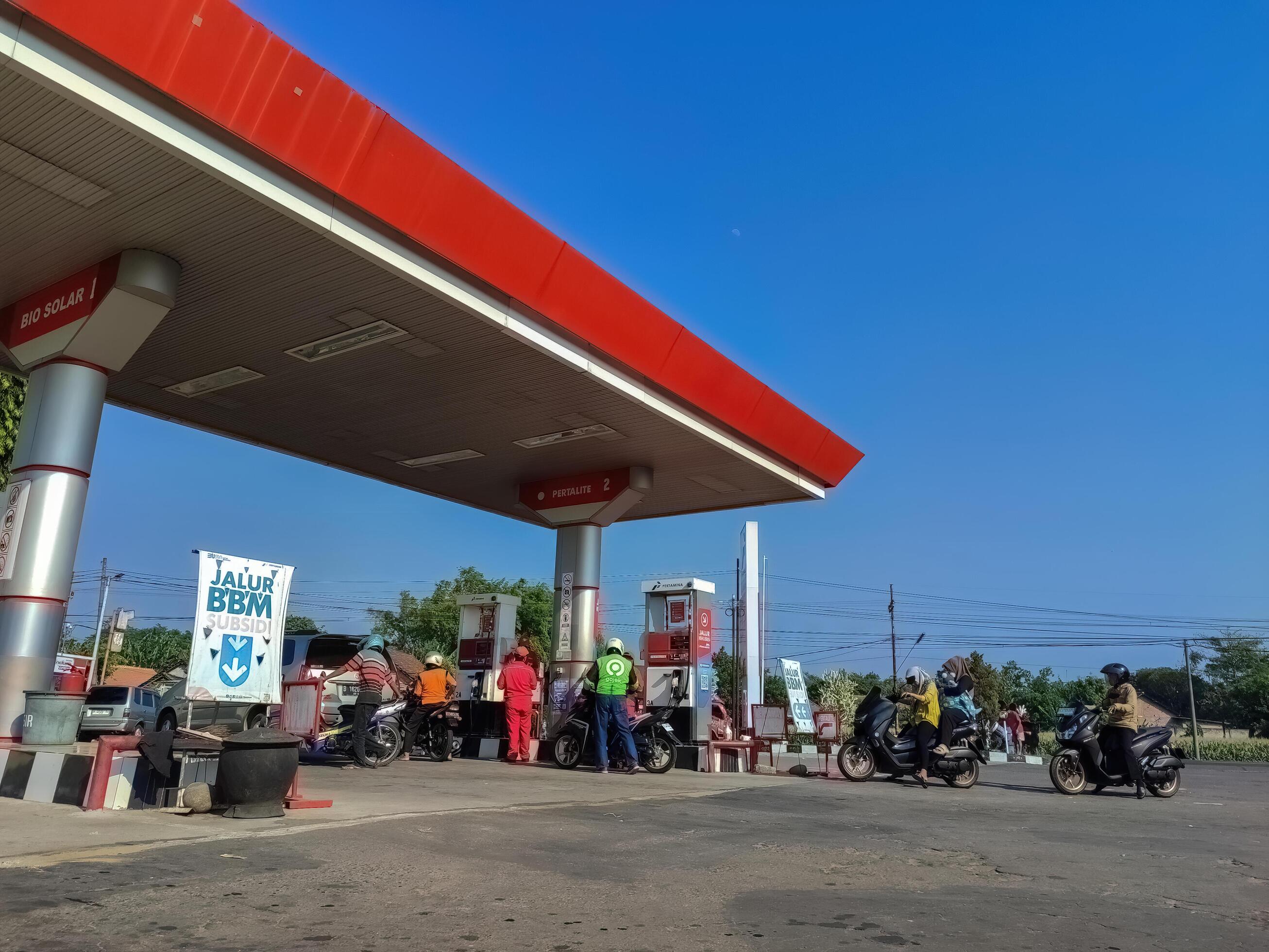 fuel queue at a Pertamina gas station. suitable for news on fuel shortages, energy crises, and ...