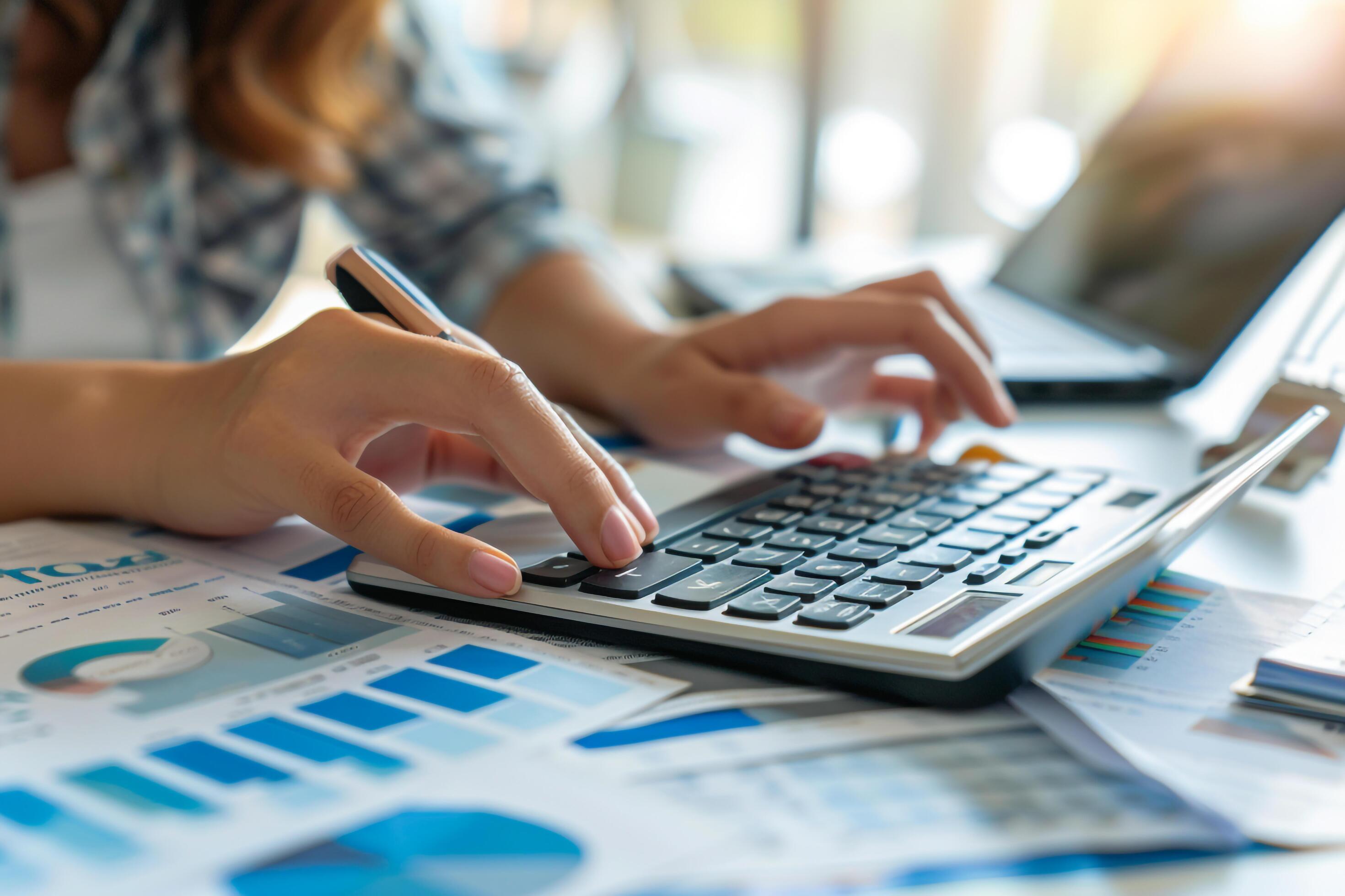 Pair of Hands Using Calculator for Tax Return Computation Background ...