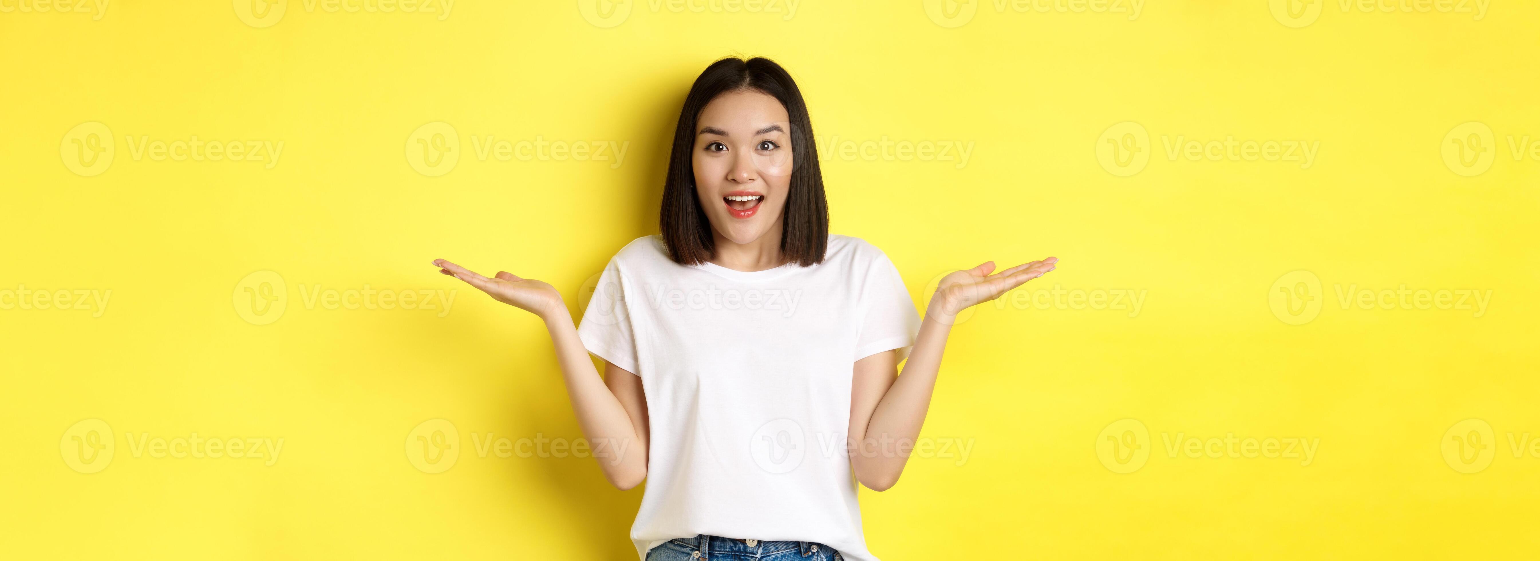 Beauty And Fashion Concept Surprised Asian Girl Spread Hands Sideways Holding On Palms