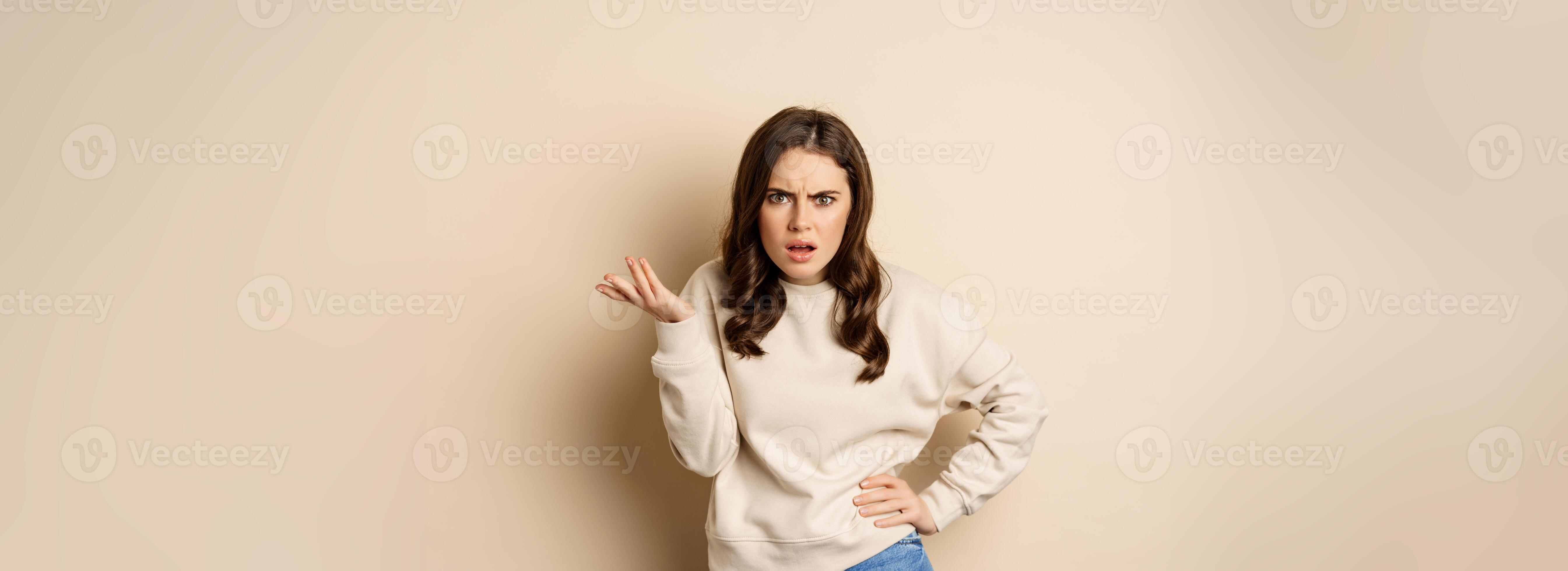 Frustrated and pissed-off woman, looking confused, arguing, standing ...