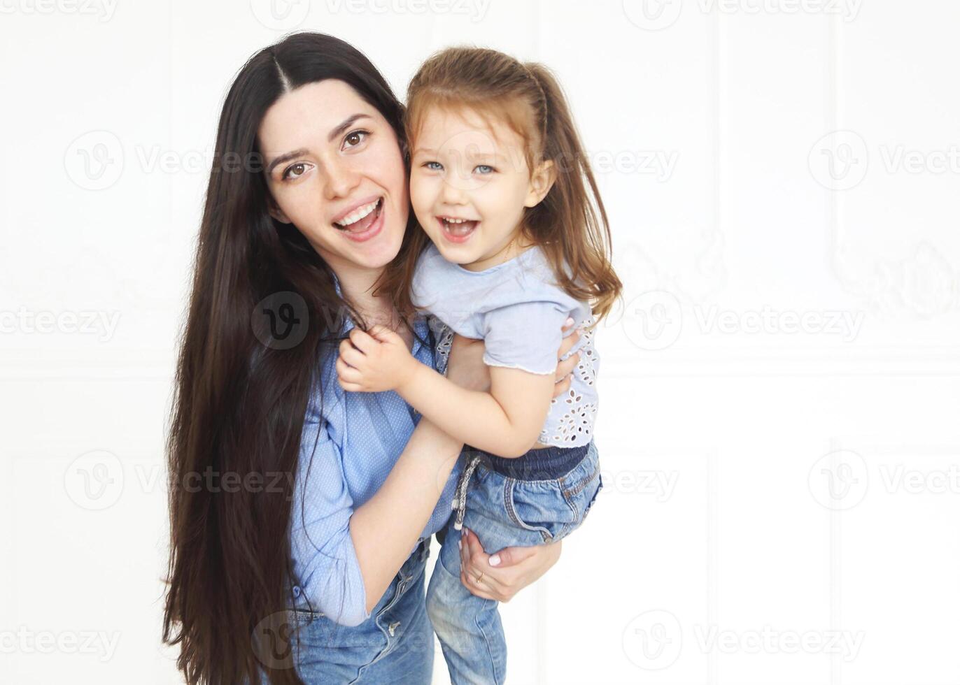 Happy young bright mother hugging her little daughter 48660256 Stock Photo at Vecteezy