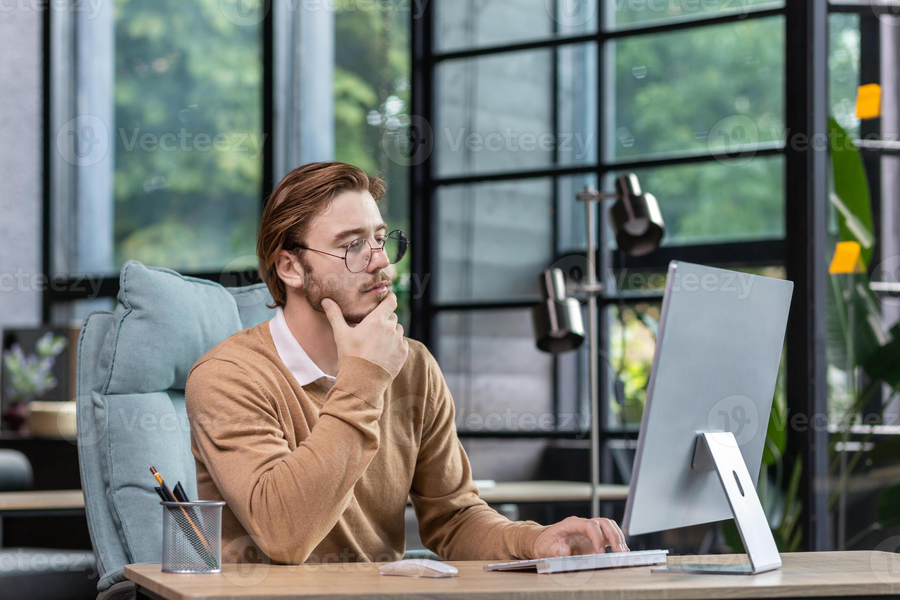 Successful young man, programmer, IT developer, software sitting at a ...