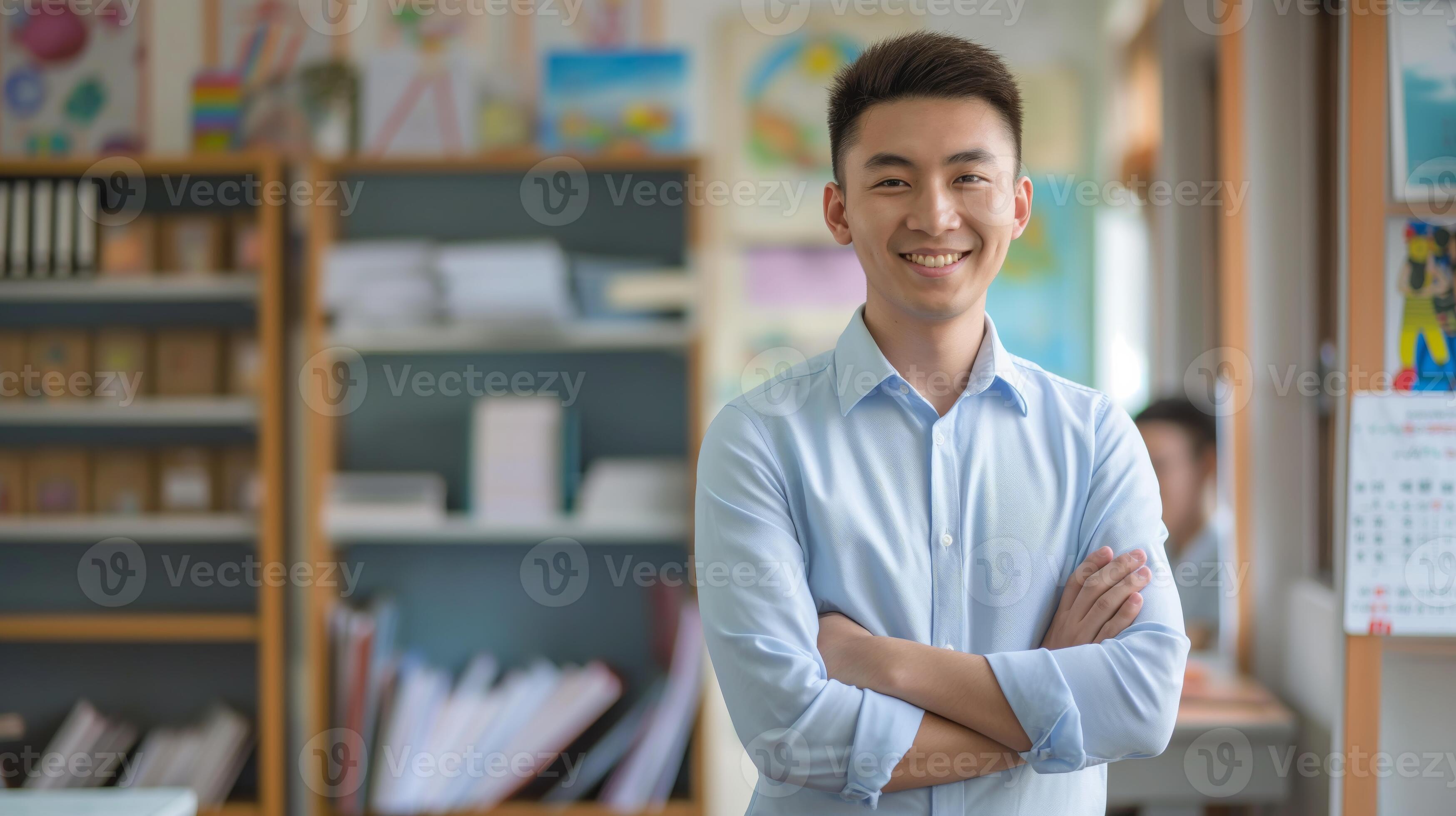 Confident Young Chinese Male School Teacher in a Classroom, Embracing Diversity and Education ...