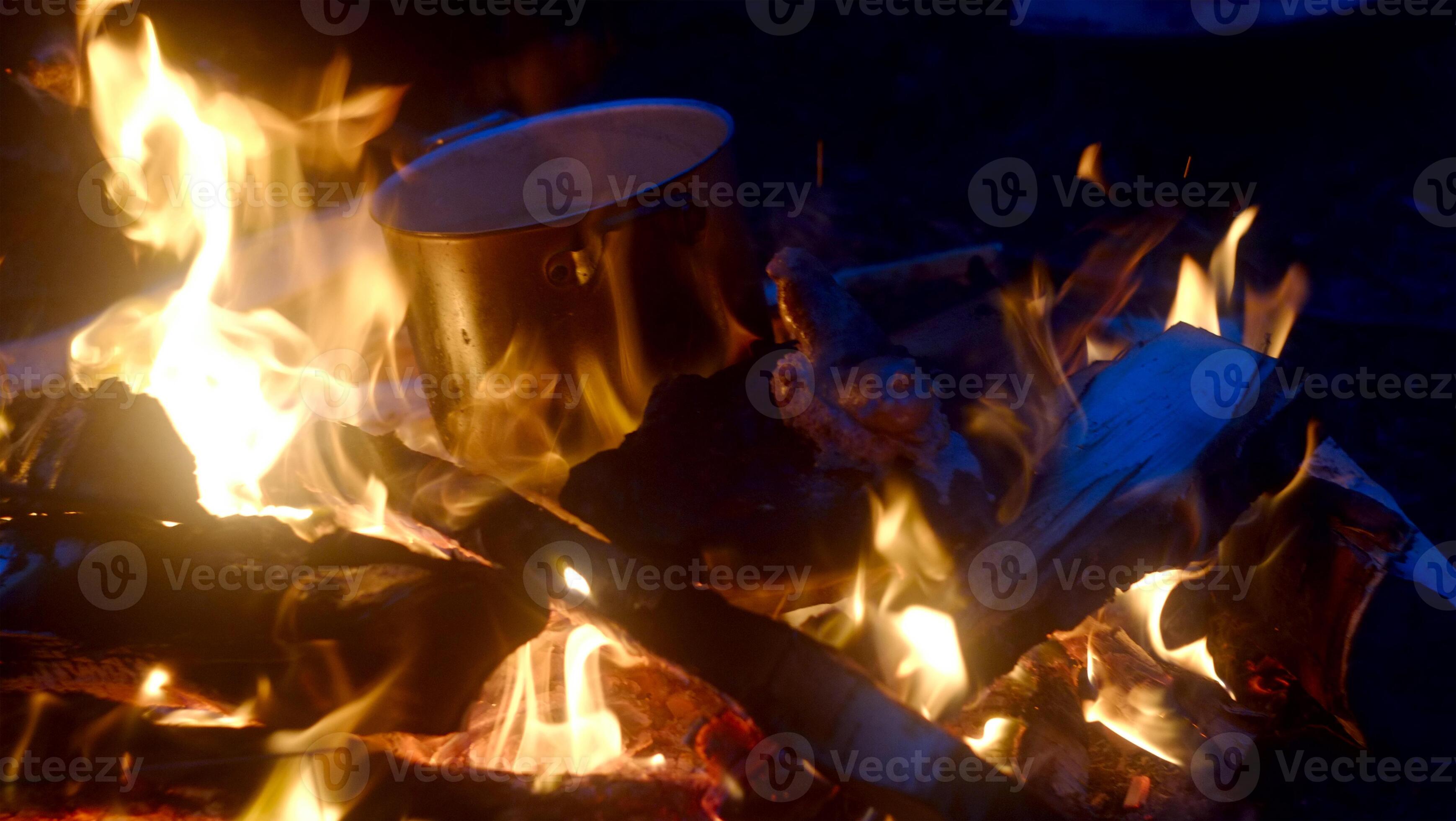 Outdoor campfire. Campfire for cooking food on a camping trip. Fire on a black background ...
