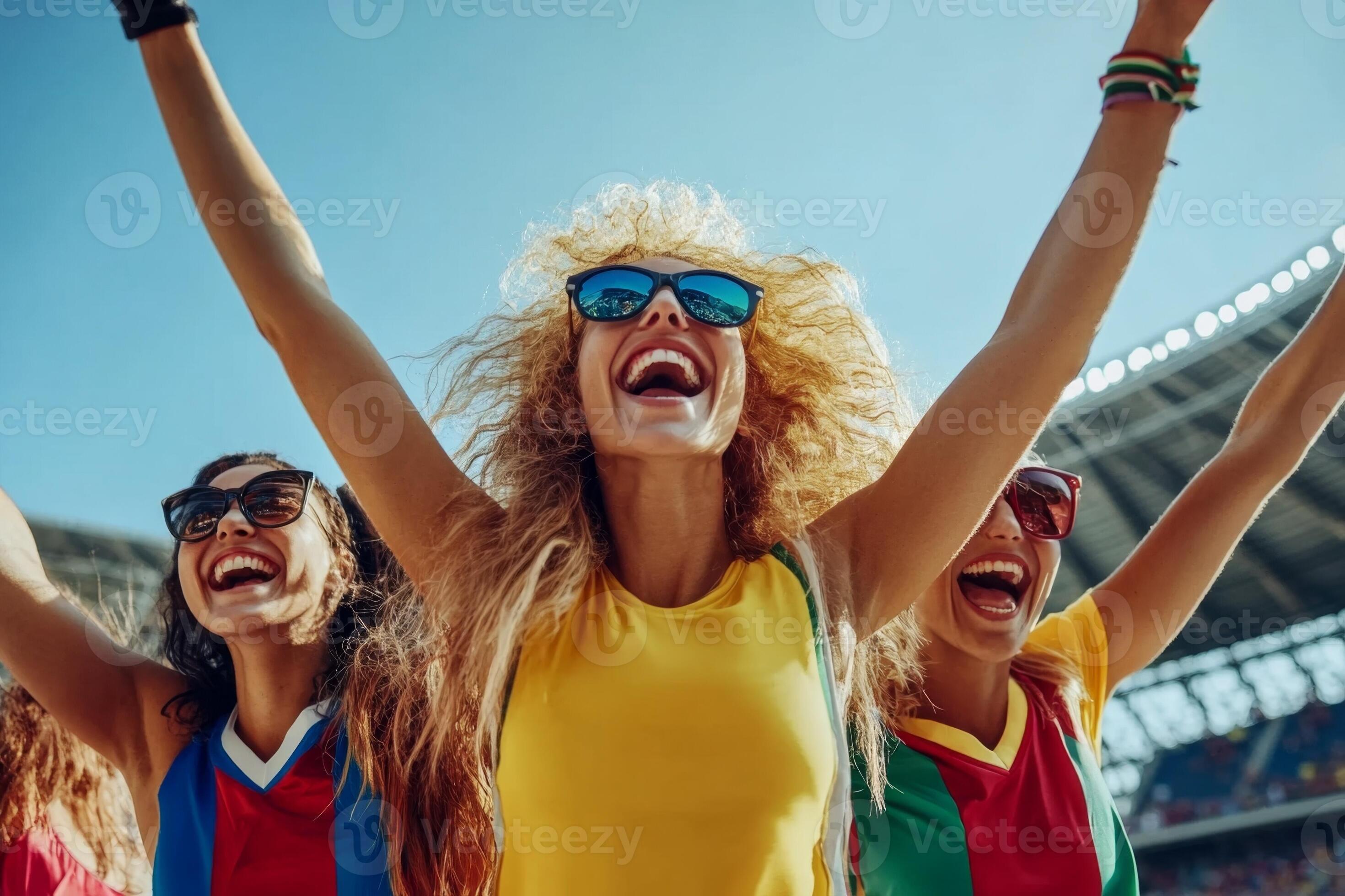 Three female friends raising arms and cheering at stadium 48804234 Stock Photo at Vecteezy