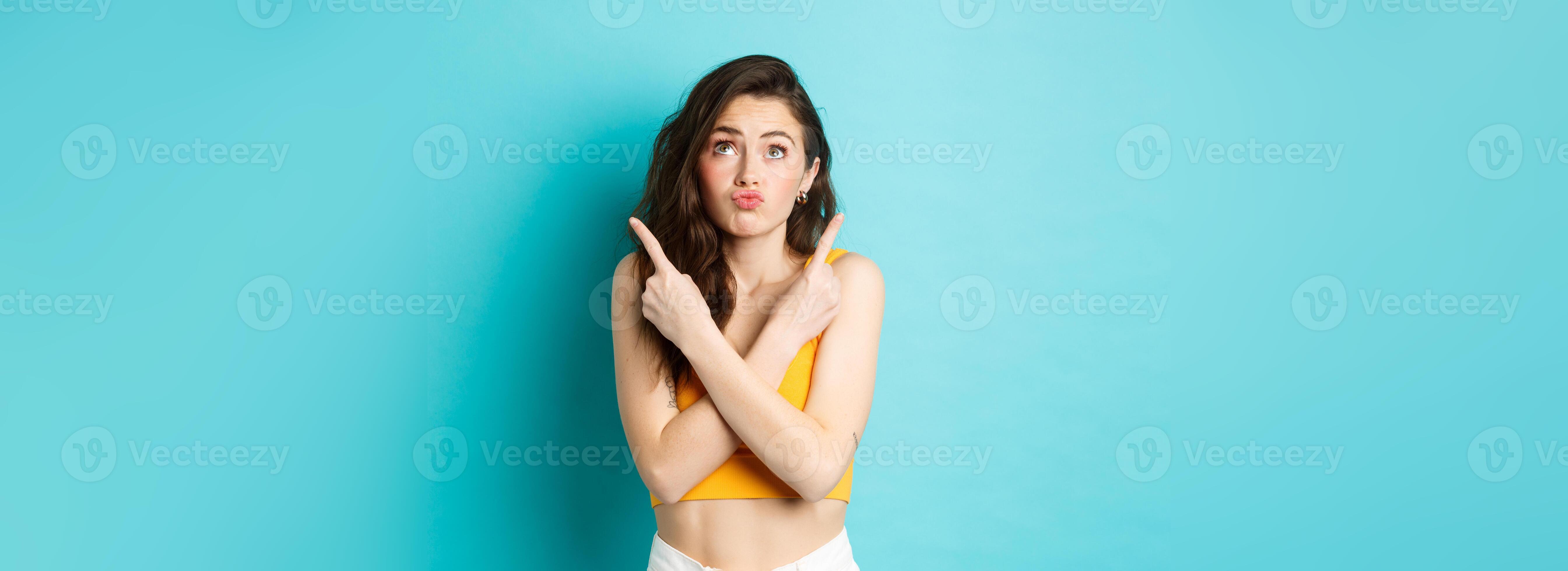 Silly indecisive girl looking question on top, pointing fingers sideways, different ways, cant ...
