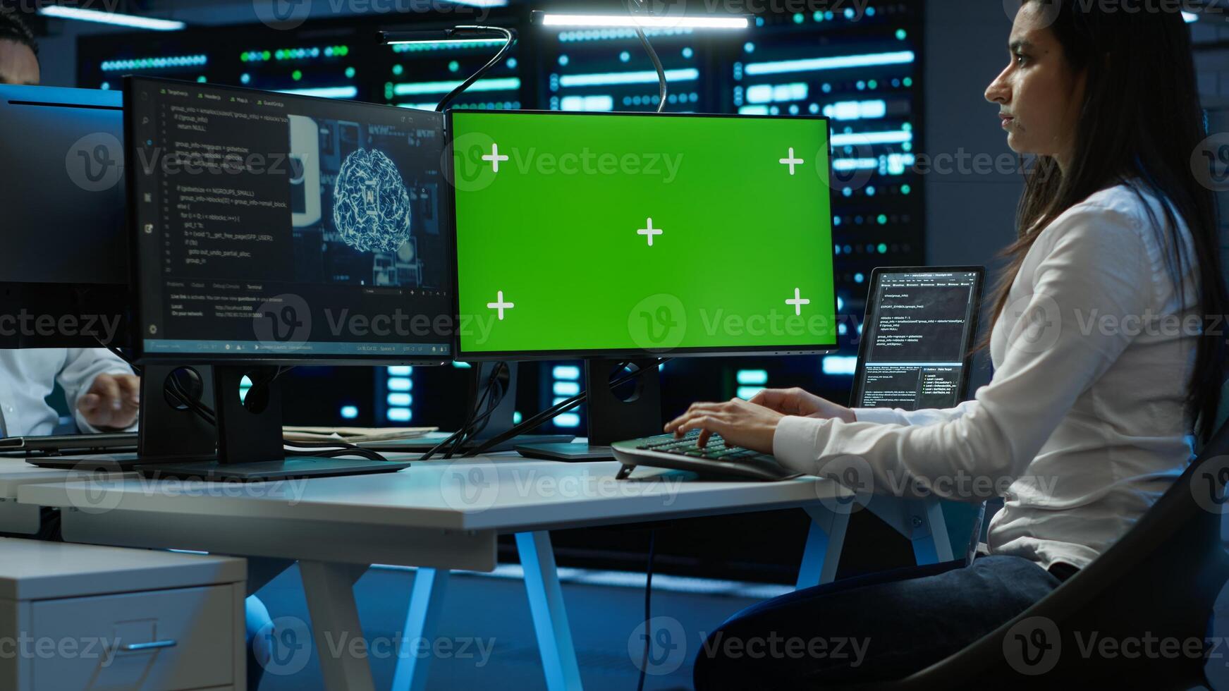 Technician doing checkup on green screen server hub PC to optimize it for data processing ...