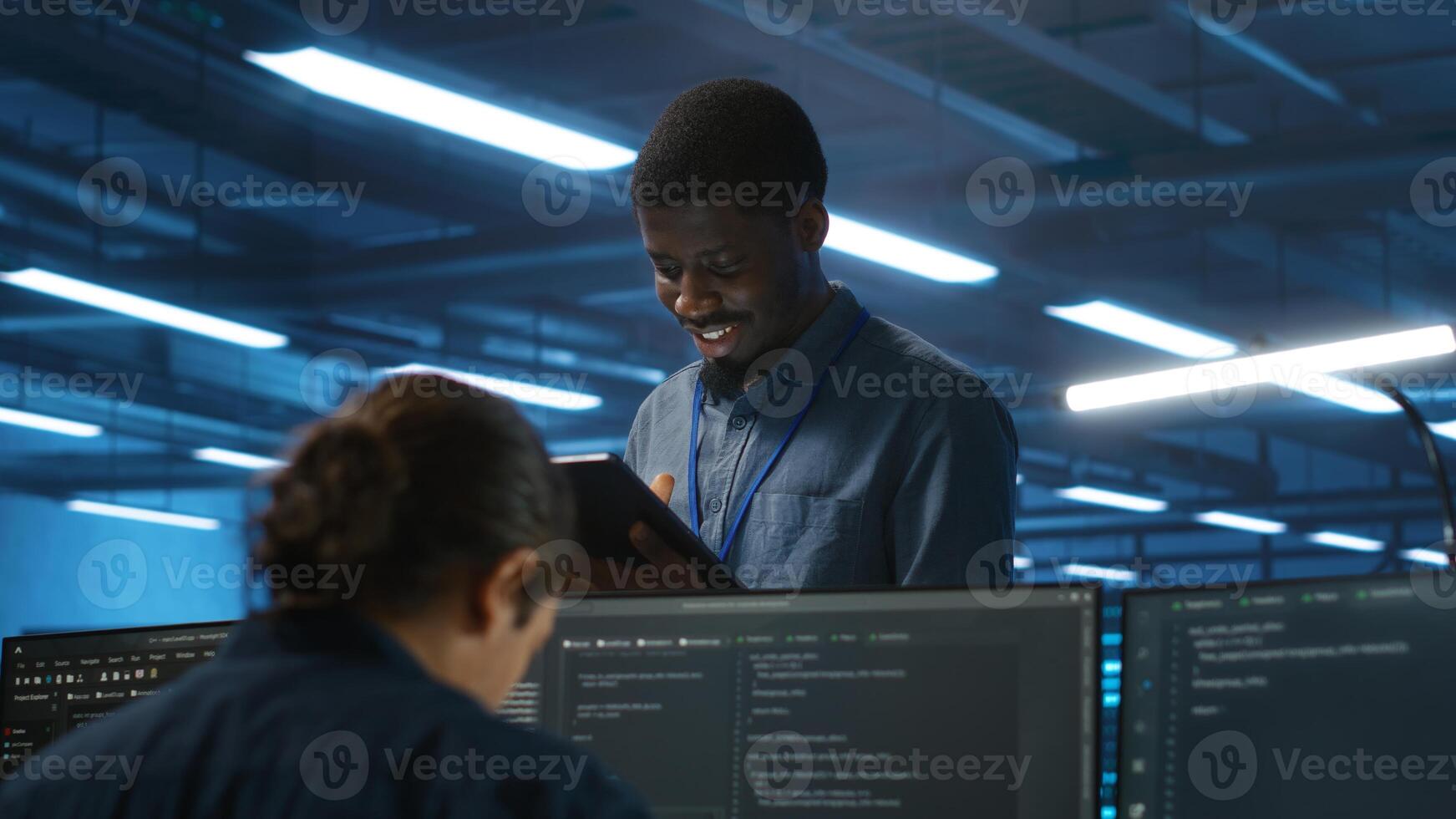 Manager Overseeing Team And Doing System Analysis Of Server Farm Supercomputers Using Tablet
