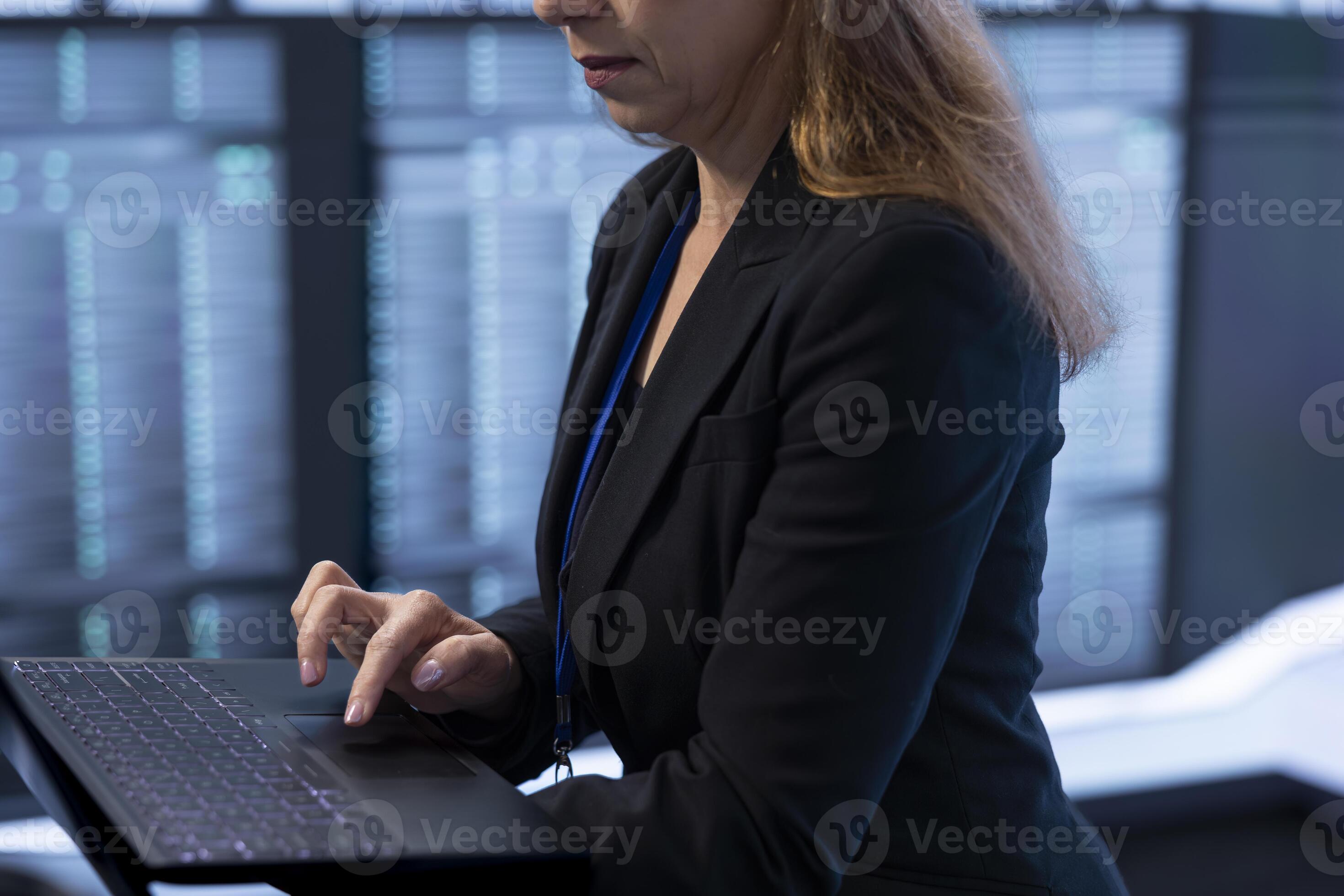 Software developer in data center checking rigs and hardware, doing checkup. Close up of ...