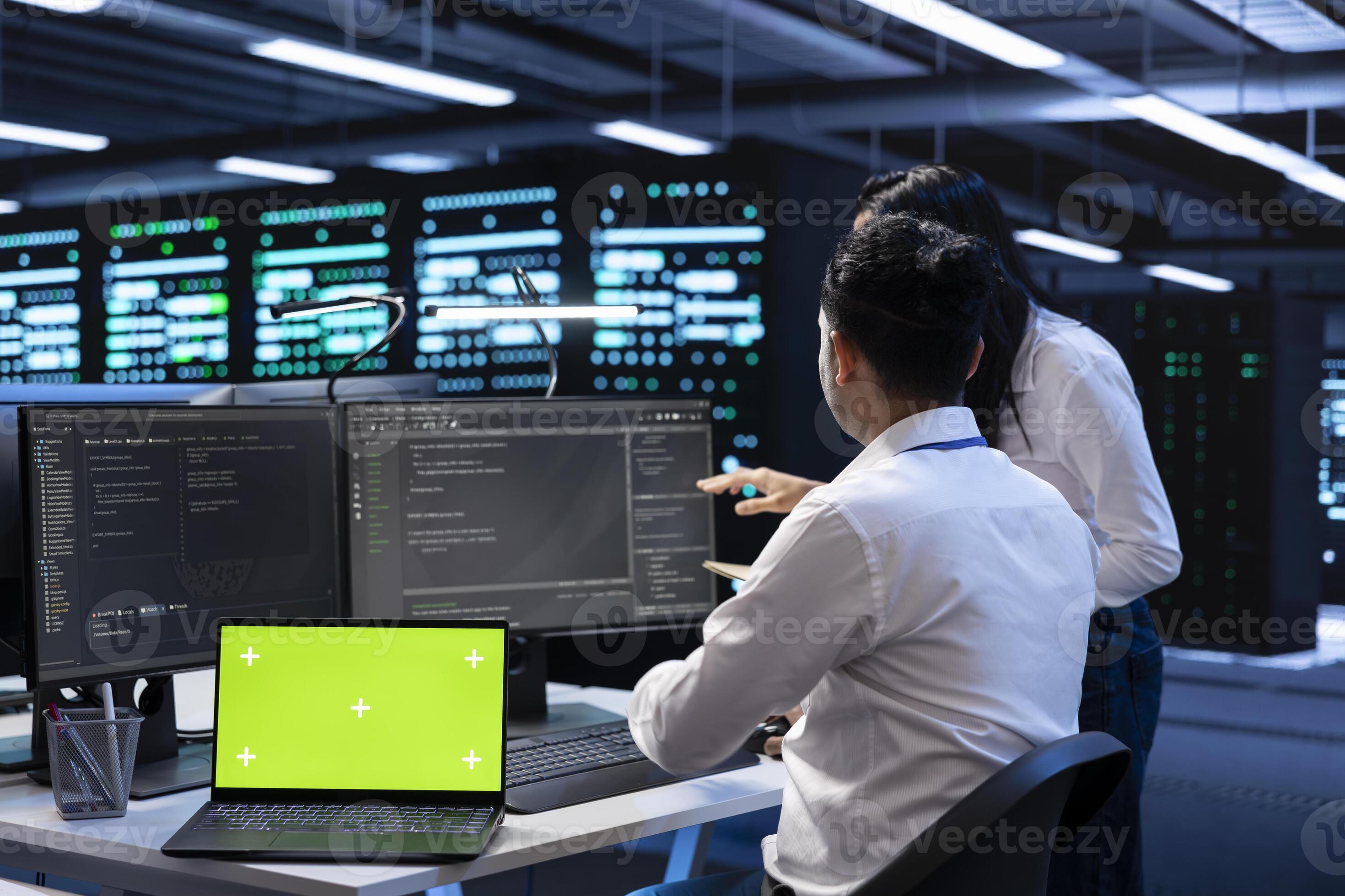 Team of technicians in data center using isolated screen laptop to find ... Team of technicians in data center using isolated screen laptop to find ...