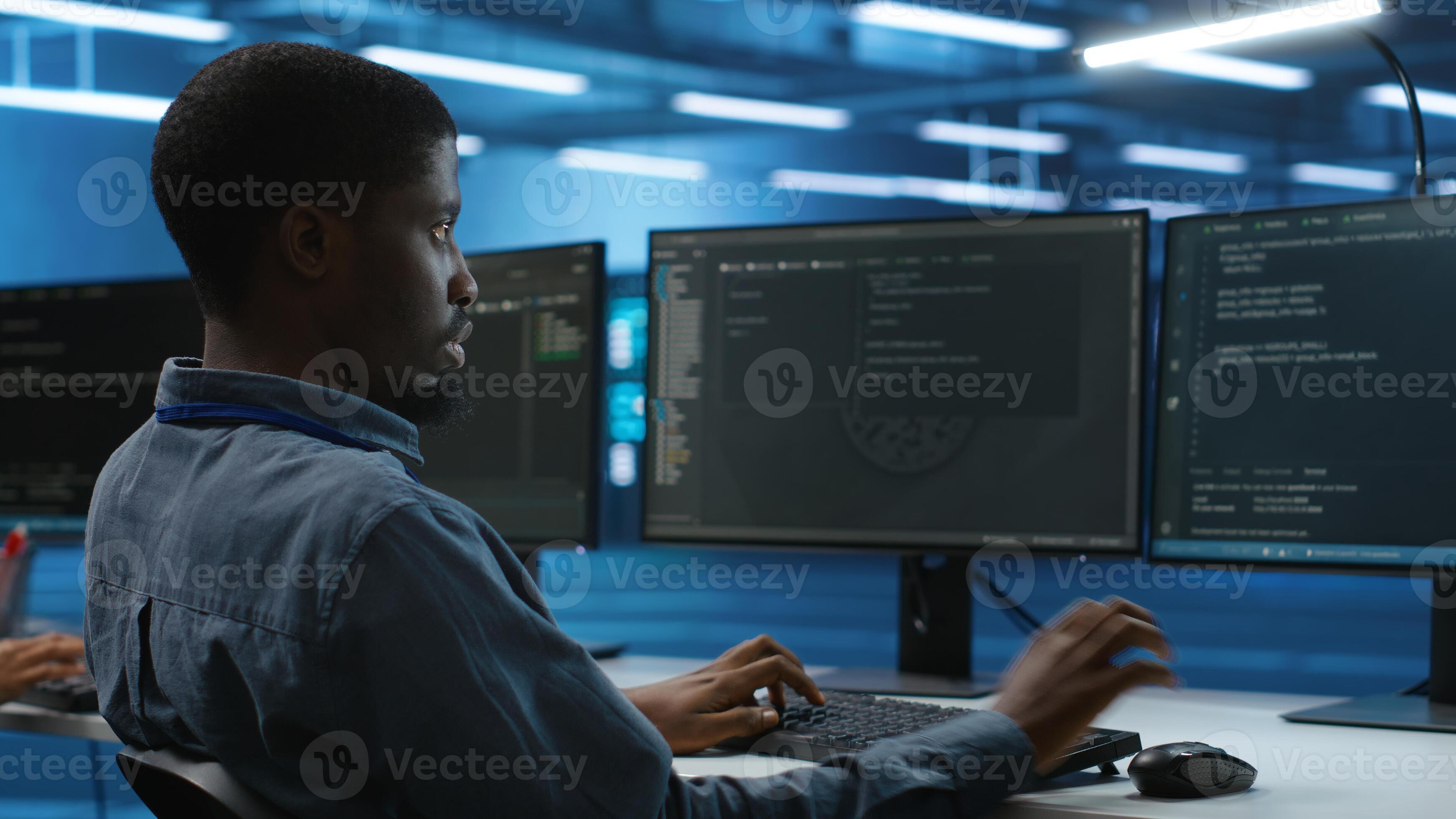 IT specialist in server farm ensuring valuable data remains shielded from potential threats ...